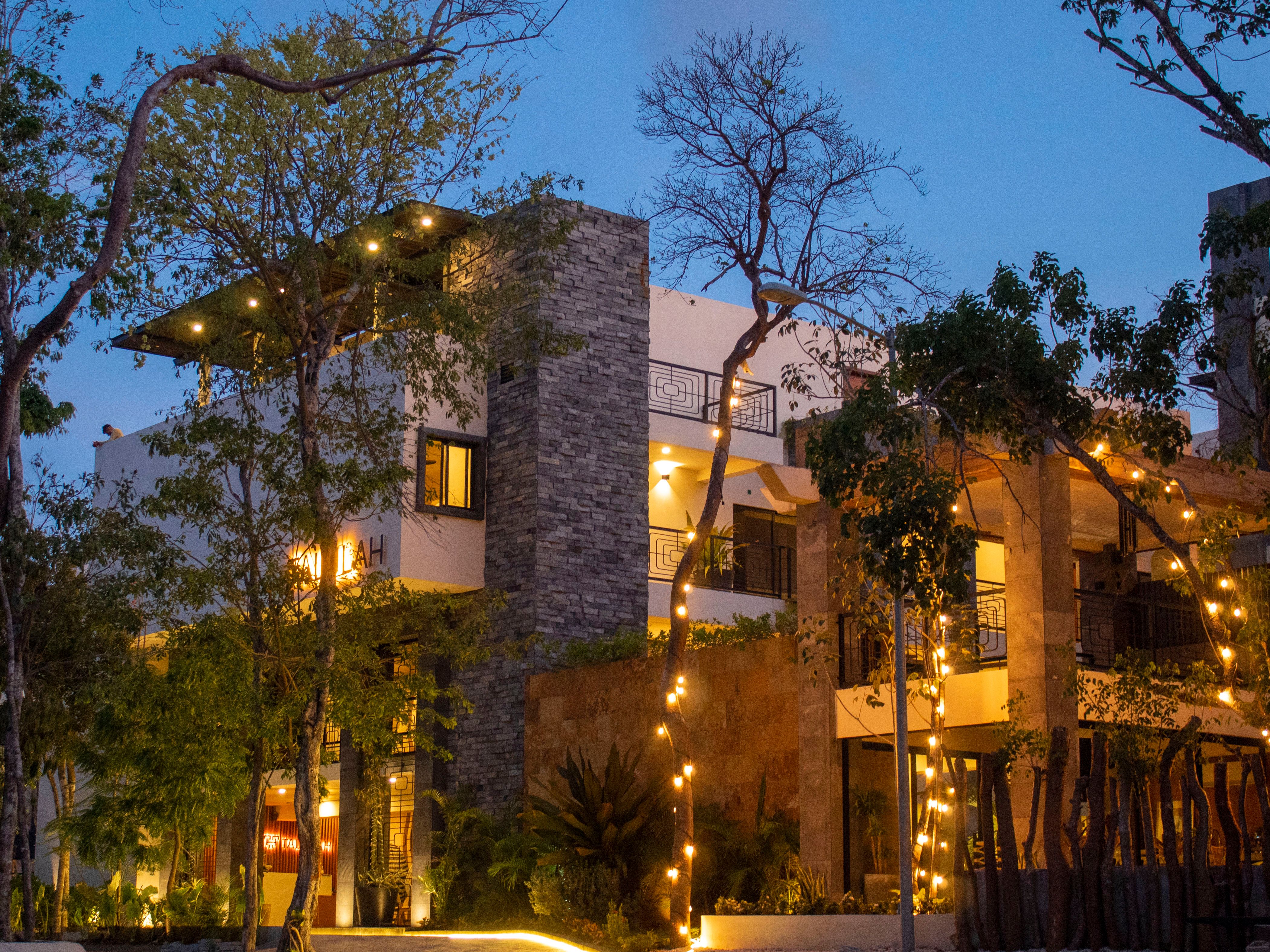Illuminated Hotel Building at Dusk · Free Stock Photo
