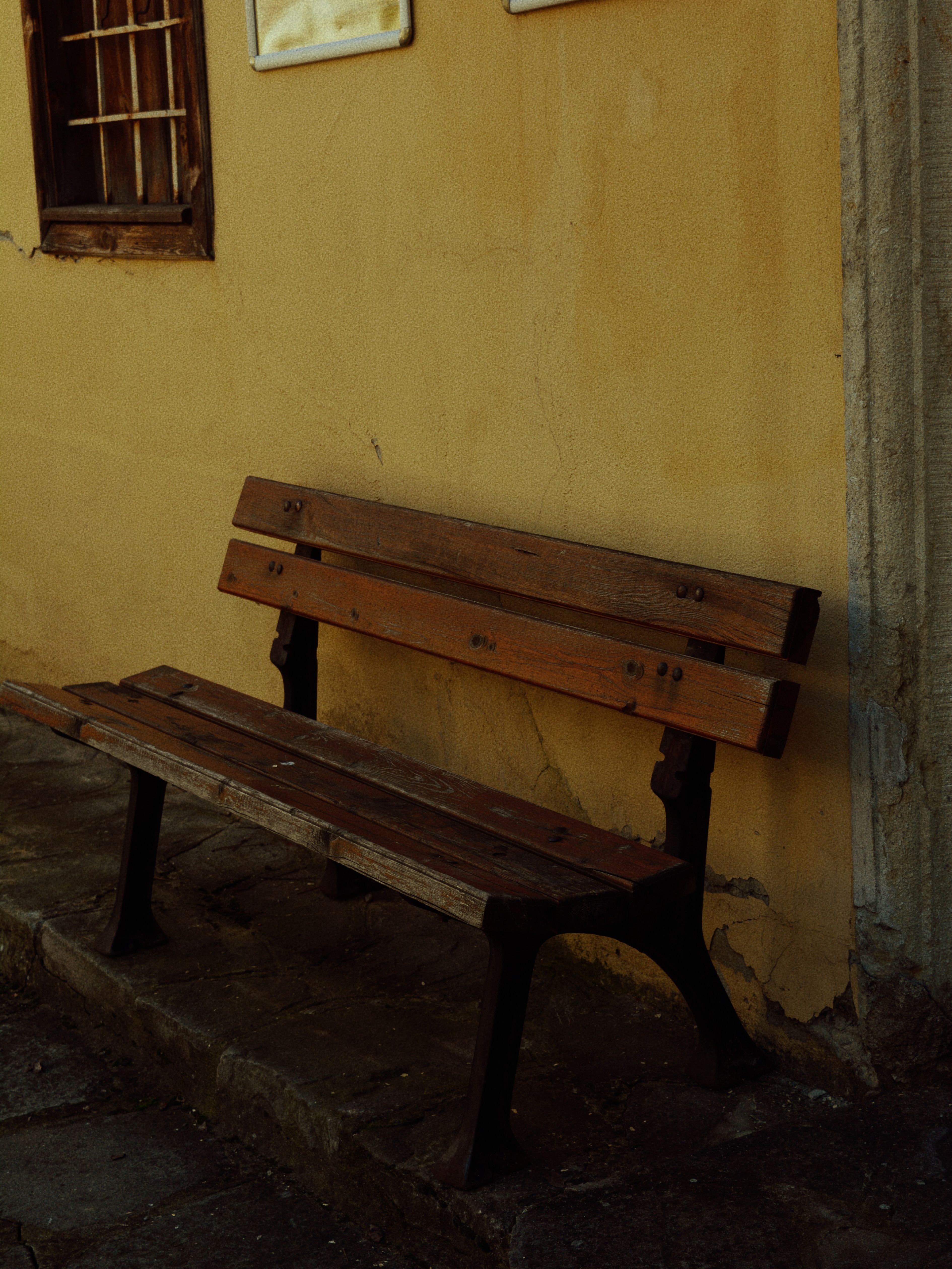 An Empty Bench Standing in Front of a Building · Free Stock Photo