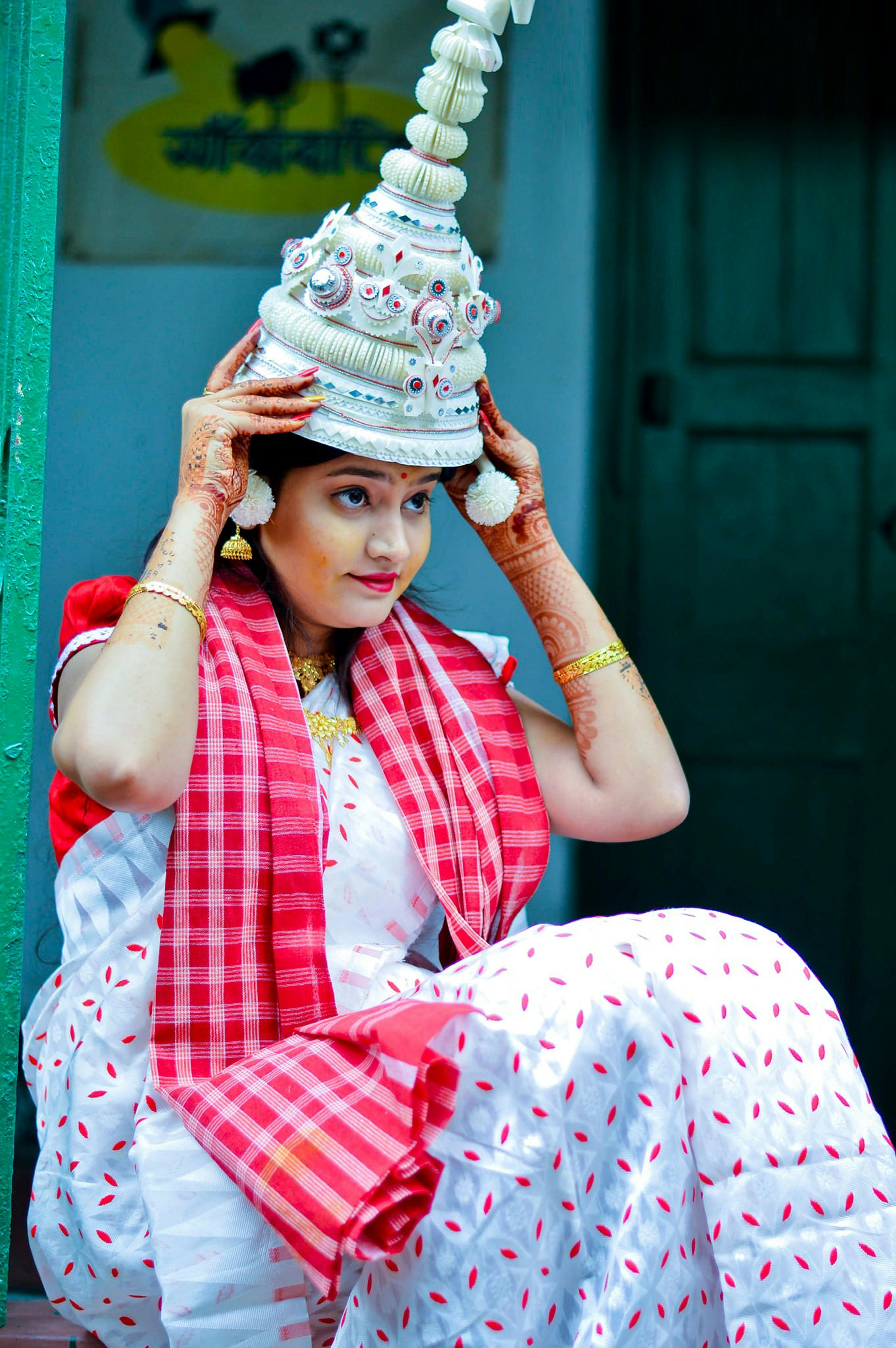 Young Woman Putting On a Traditional Topor · Free Stock Photo