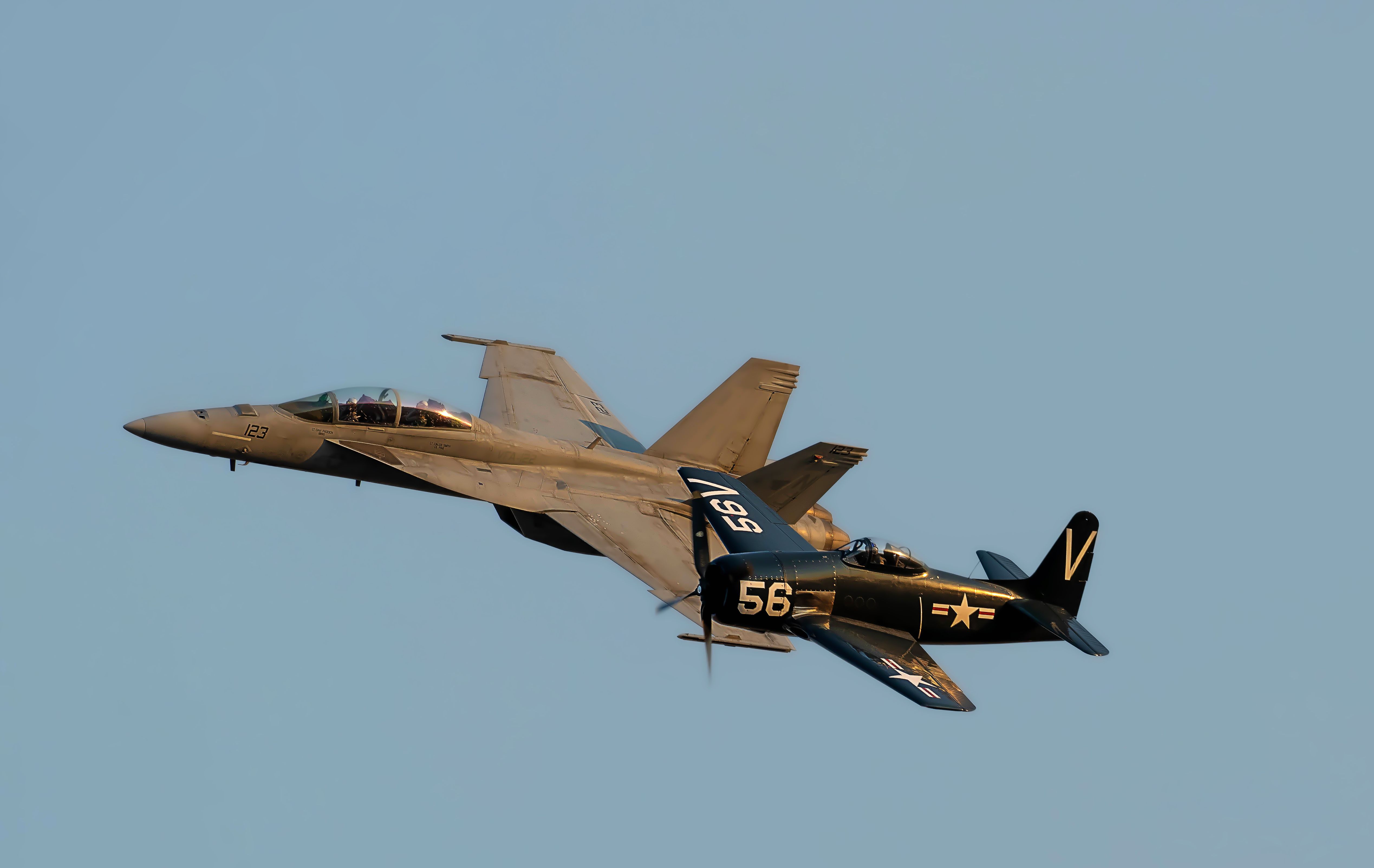 F/A-18 Hornet Jet Flying Alongside a Vintage Grumman F8F Bearcat ...