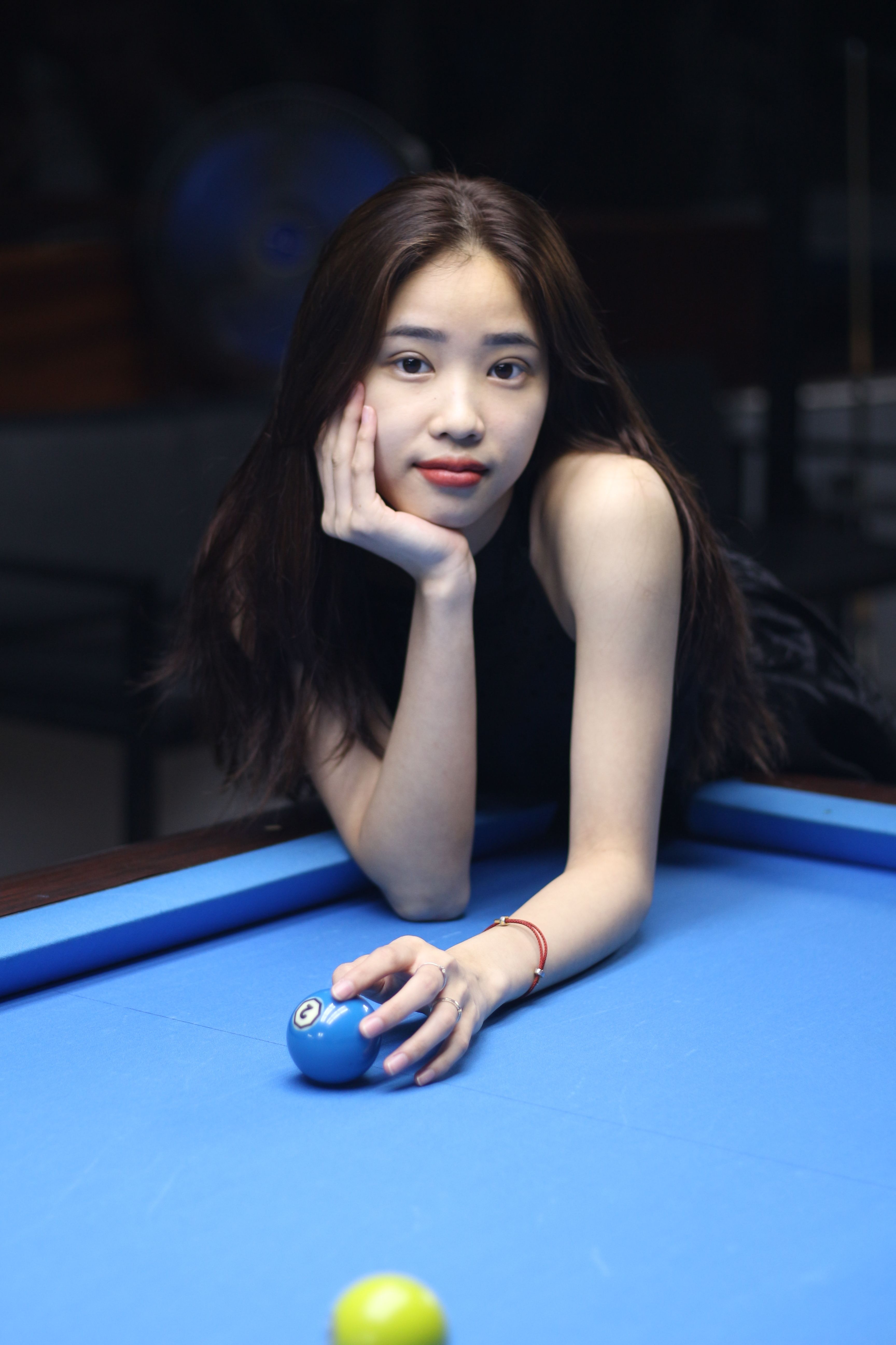 A young woman leaning over a pool table · Free Stock Photo