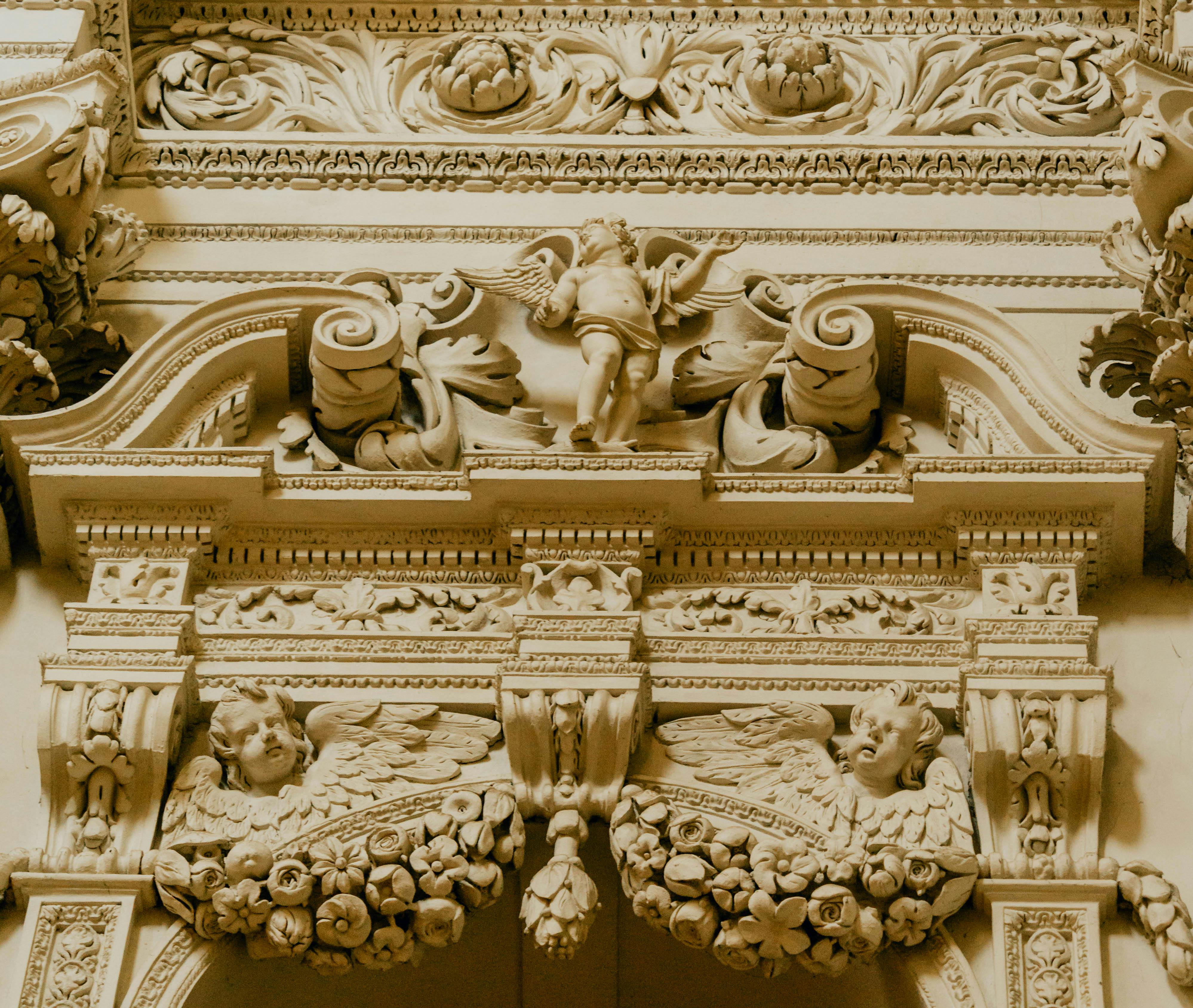 A close up of ornate carvings on a building · Free Stock Photo