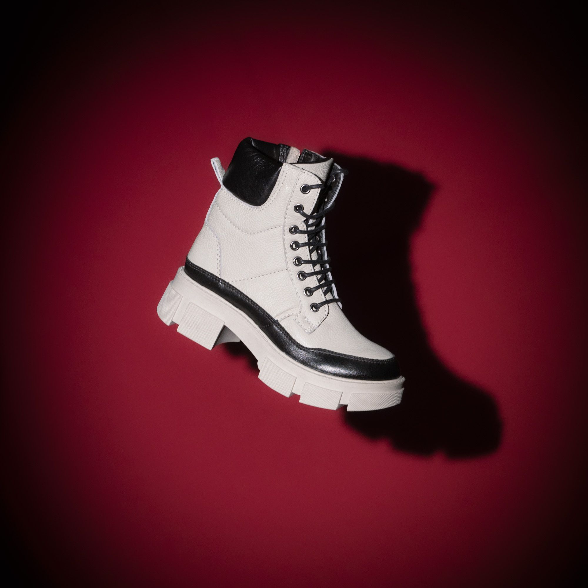 White Ankle Boot on a Burgundy Background · Free Stock Photo