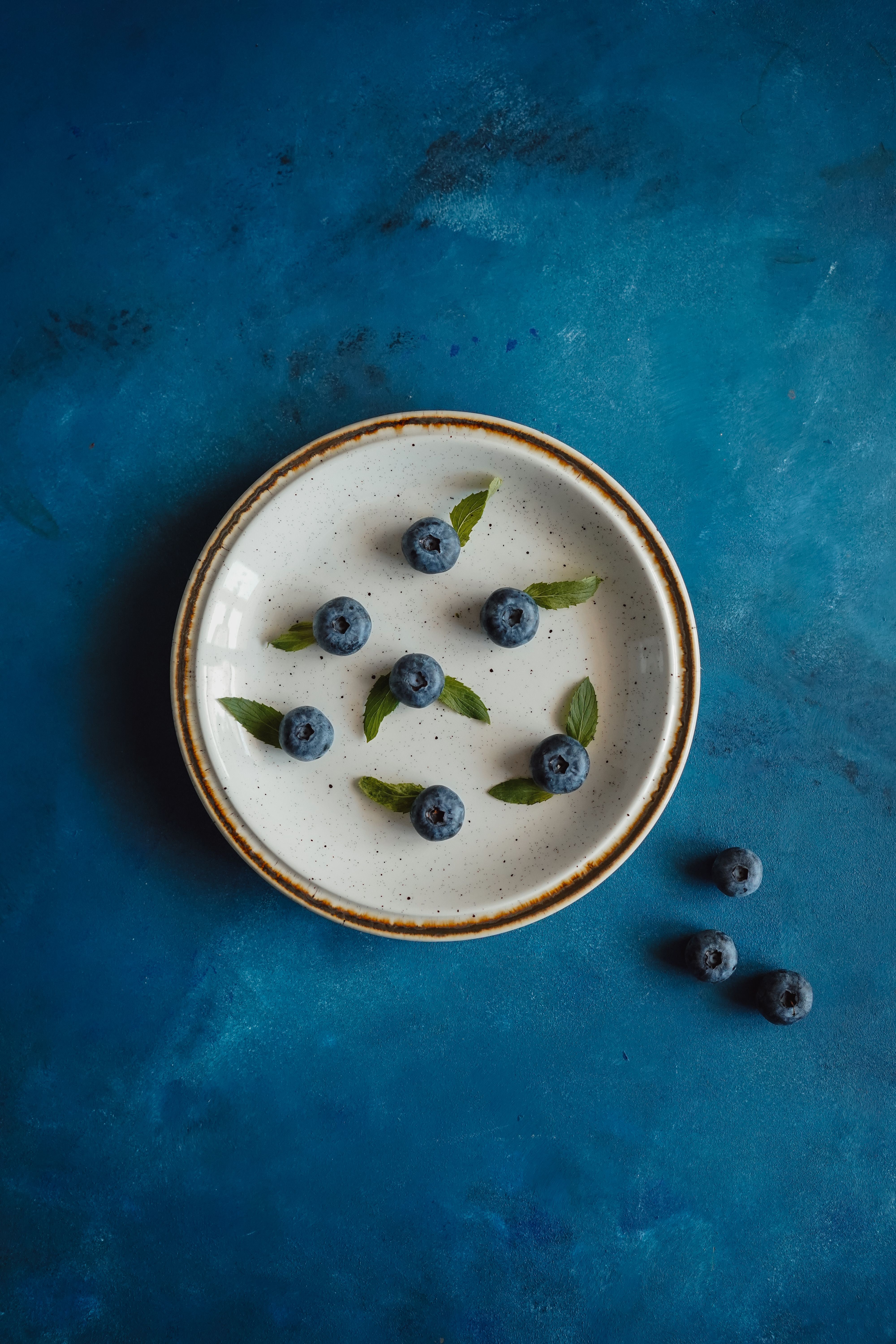 Blueberries on and near Plate · Free Stock Photo