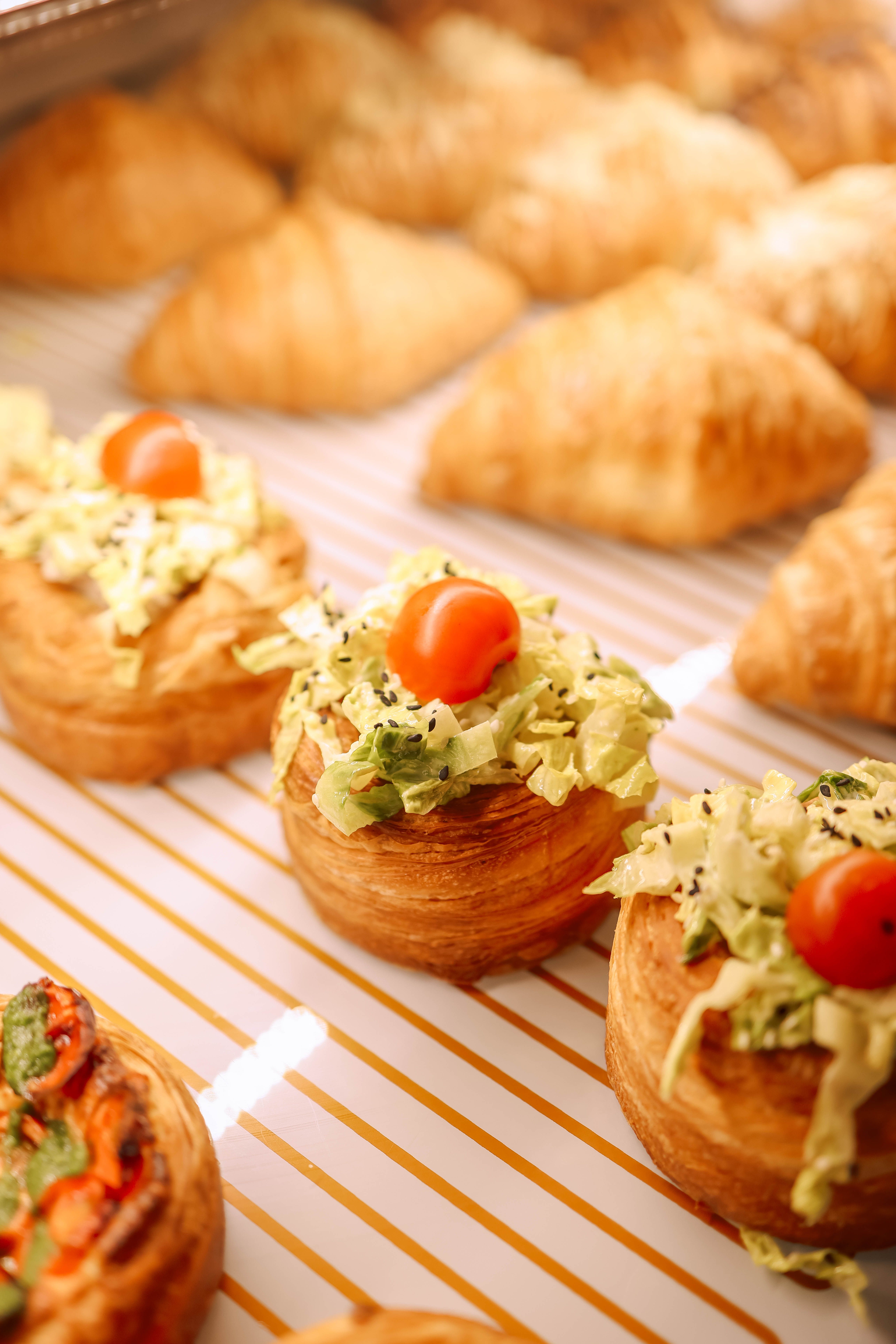 A display of pastries with tomatoes and cheese · Free Stock Photo