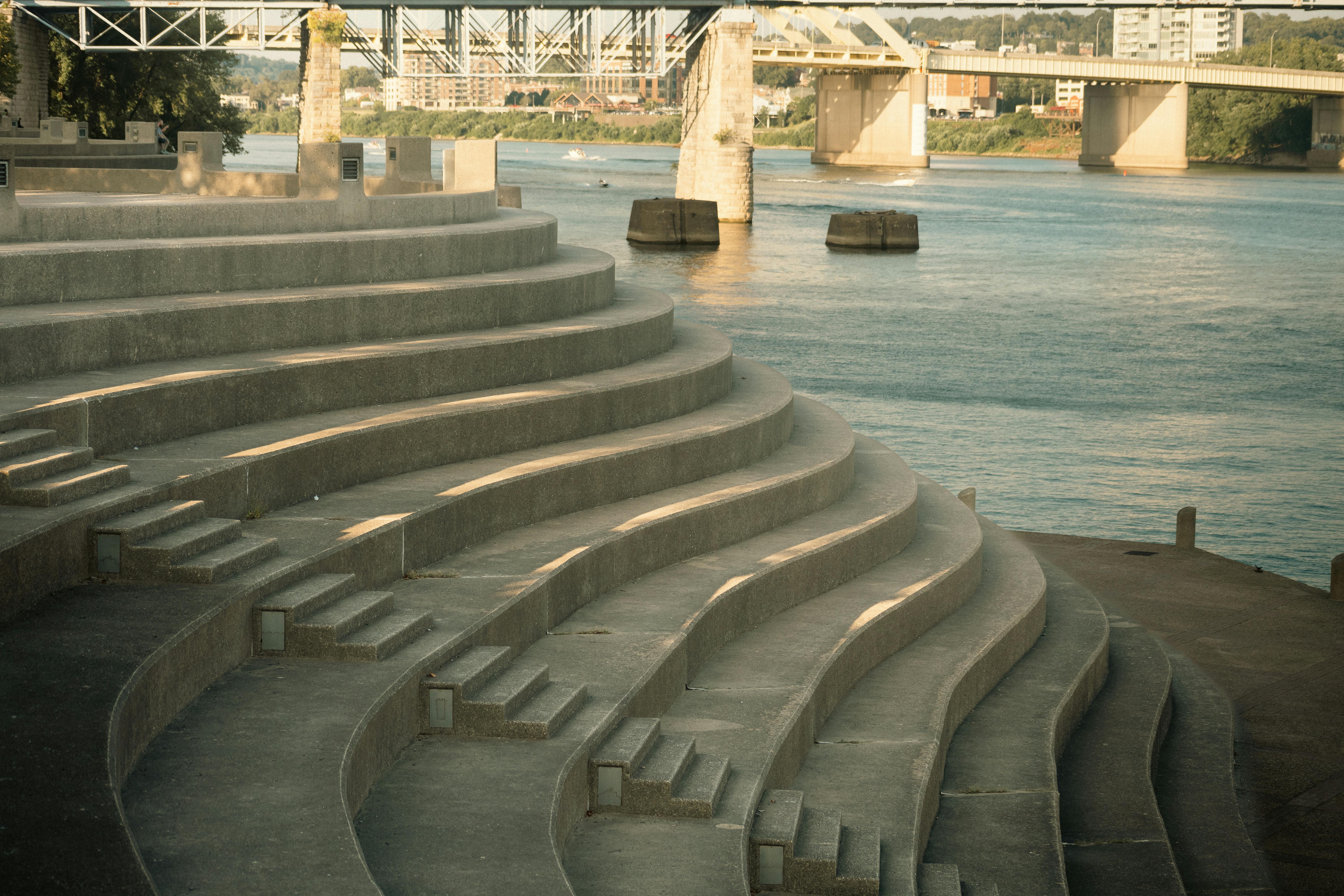 Concrete Amphitheater Overlooking River with Bridges · Free Stock Photo