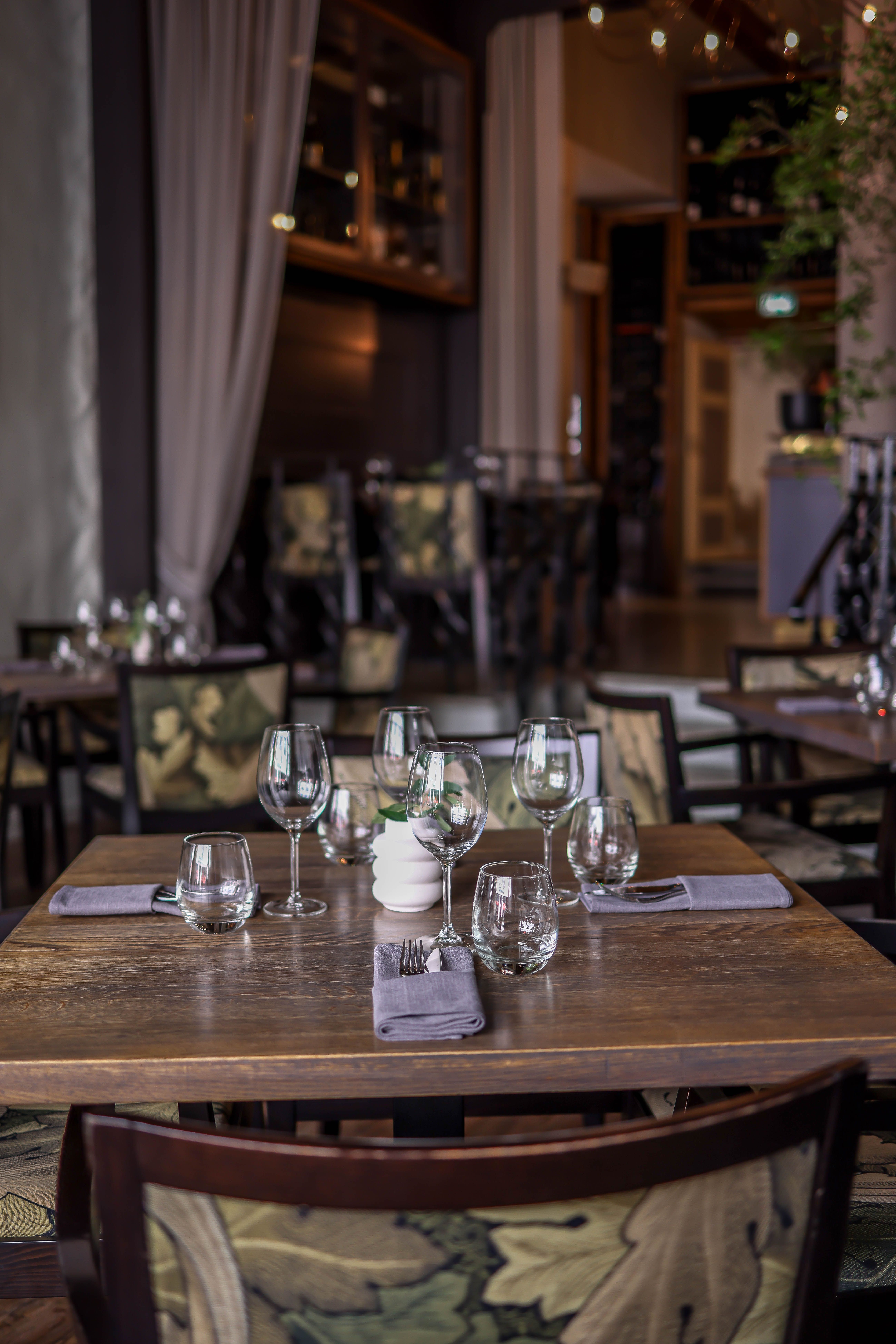 Place Settings on Wooden Table in Restaurant · Free Stock Photo