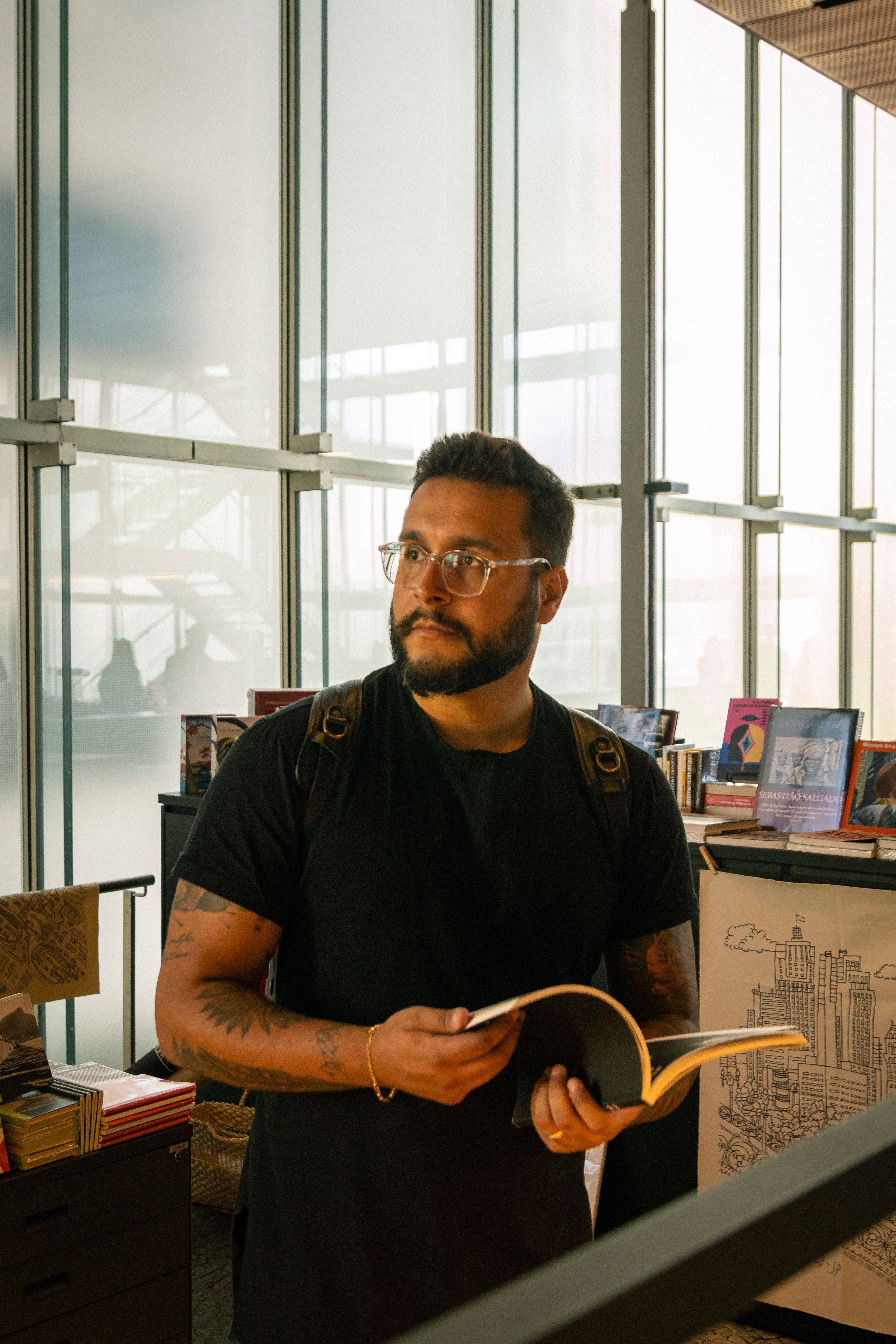 Man Holding Open Magazine in Bookstore · Free Stock Photo