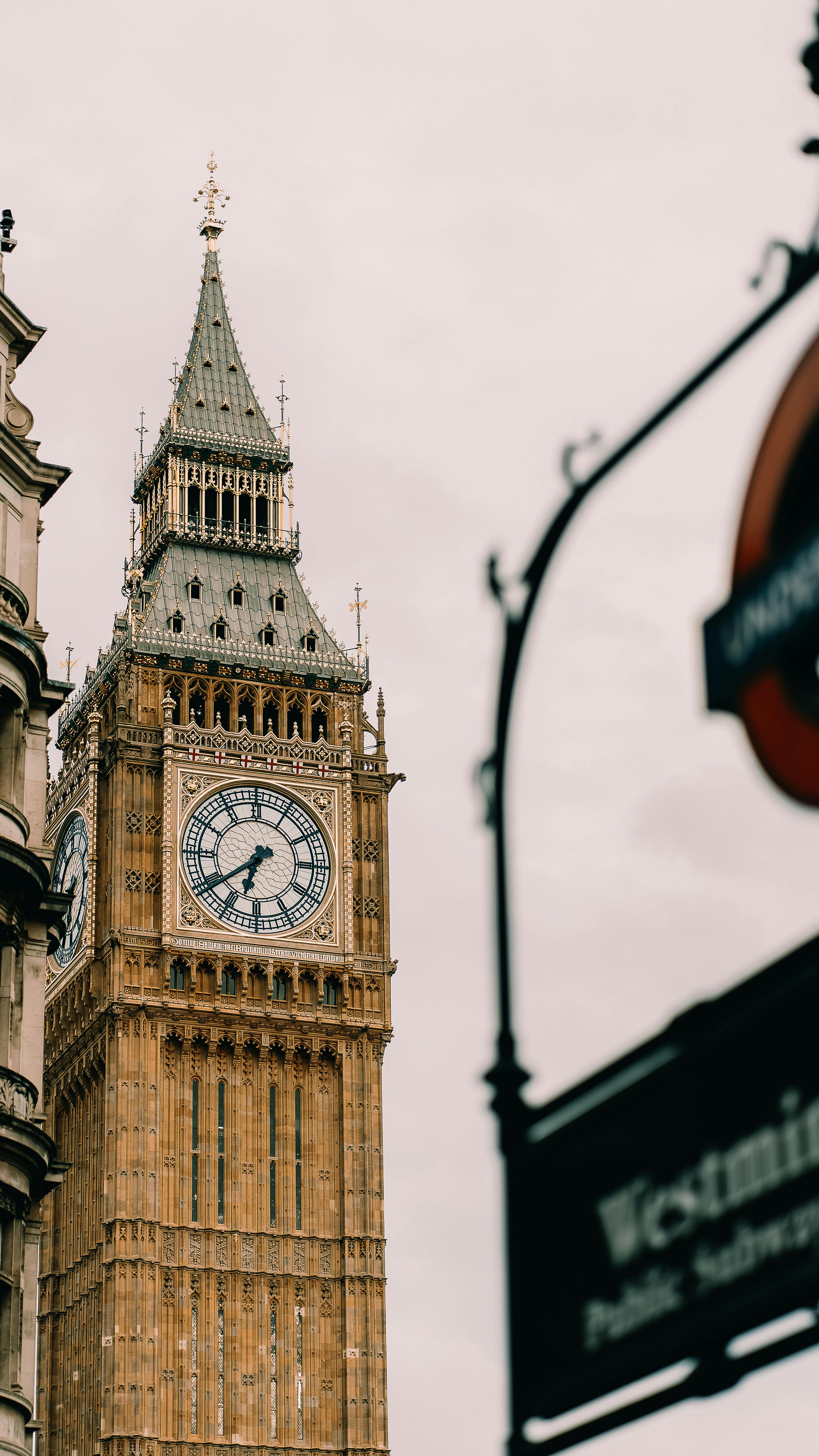 A clock tower with a big ben sign in the background · Free Stock Photo