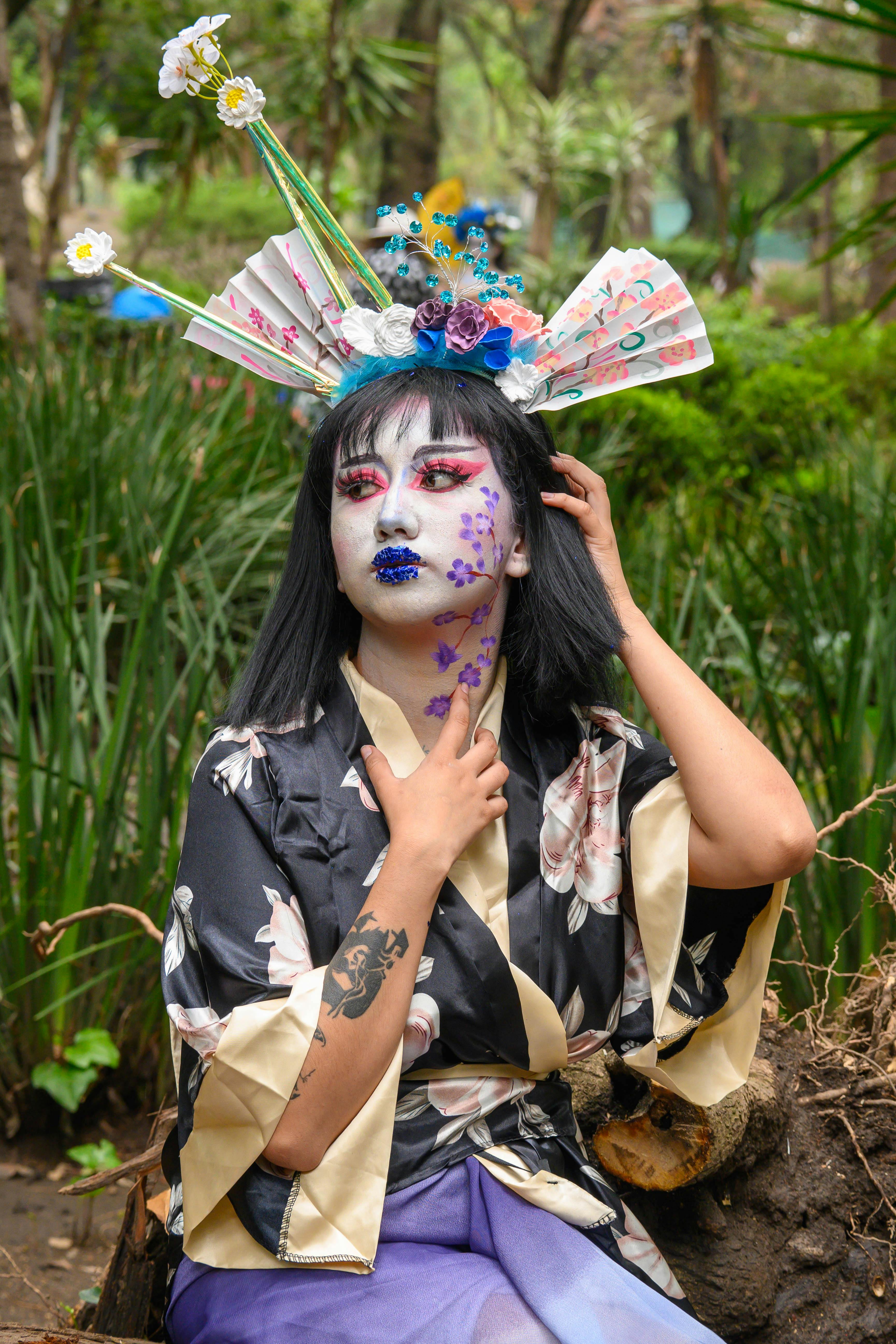 A Woman Dressed as Geisha Posing in a Garden · Free Stock Photo