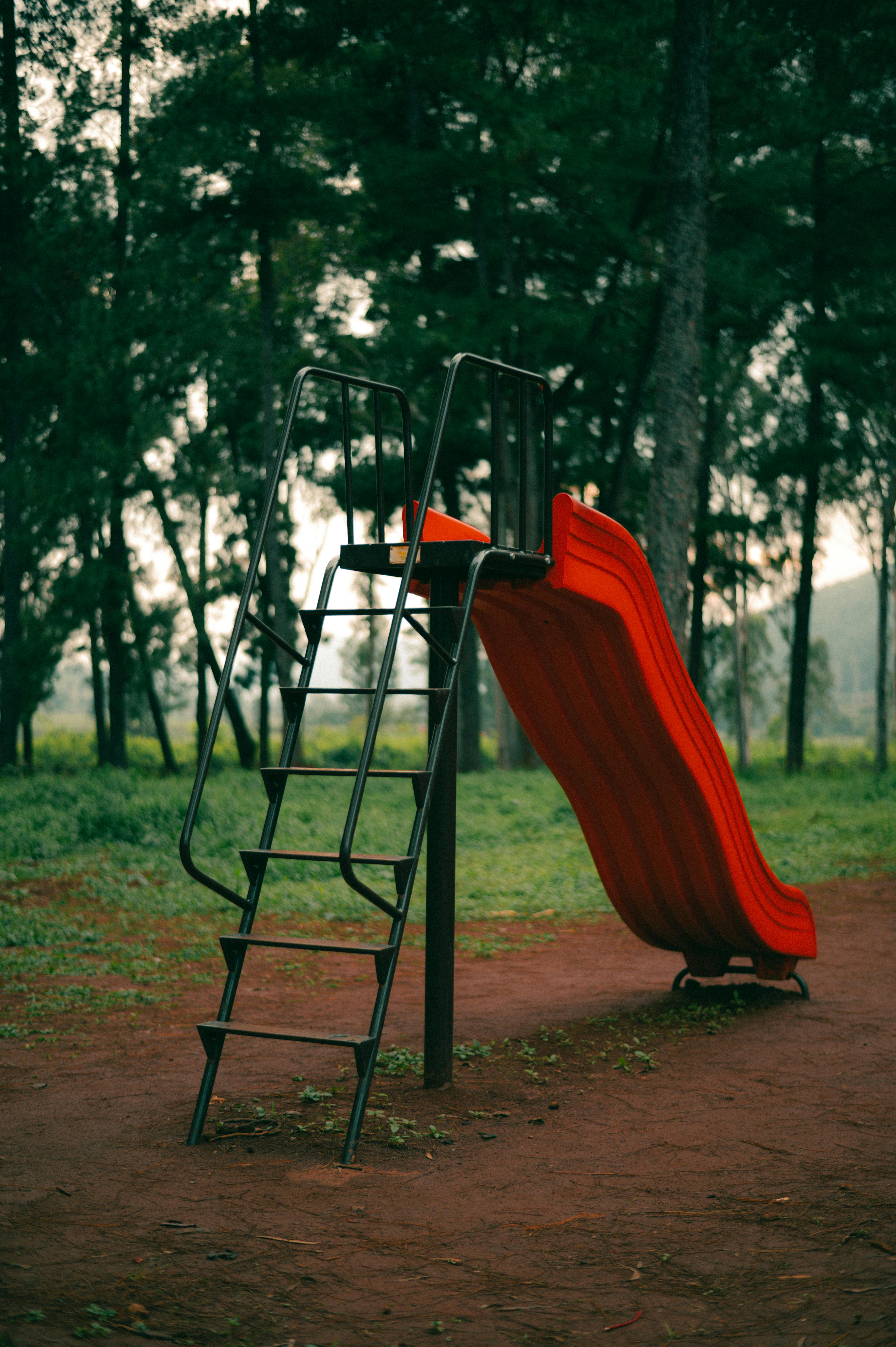 A red slide in a forest · Free Stock Photo
