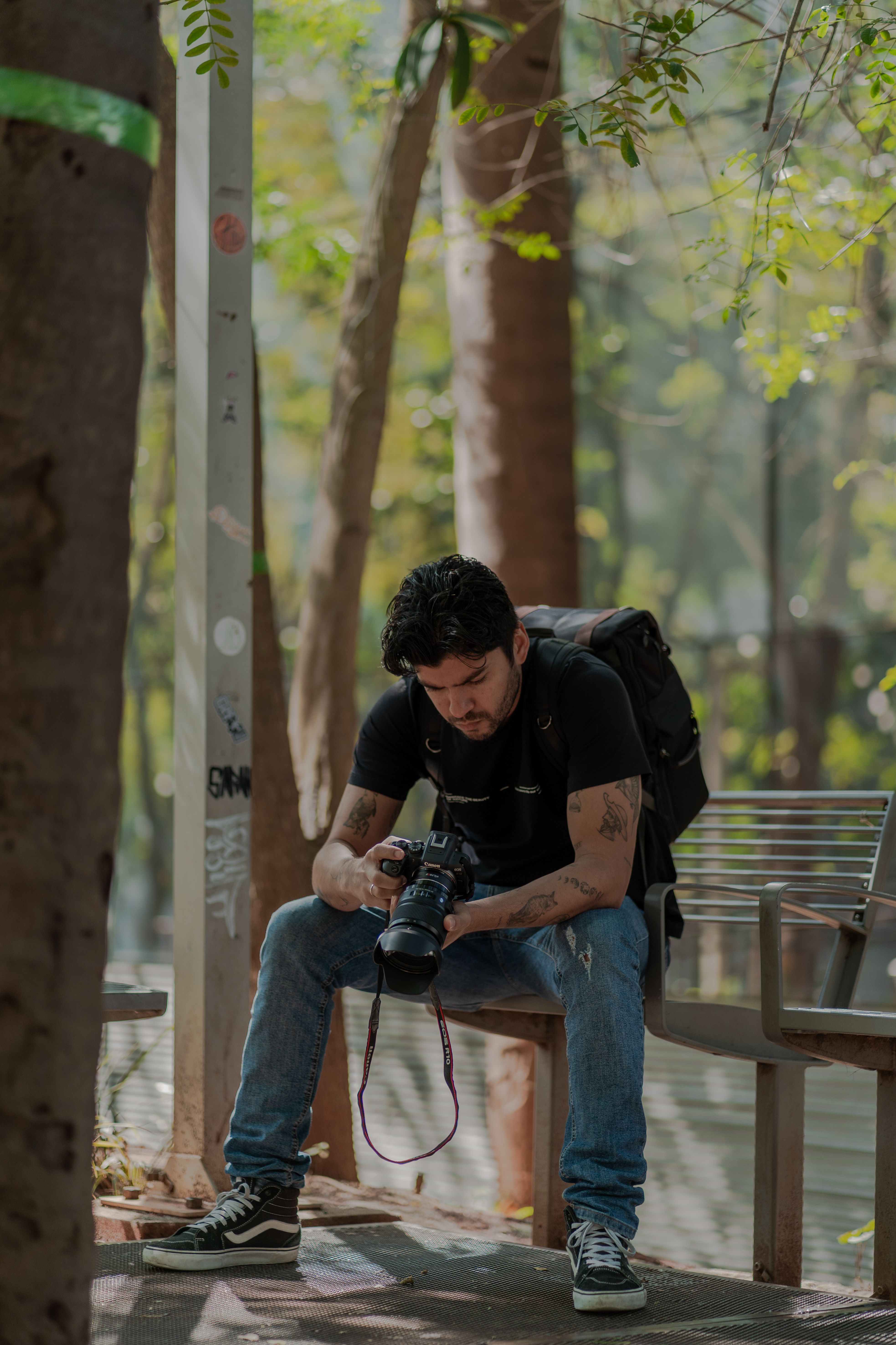 Photographer Sitting on a Bench · Free Stock Photo