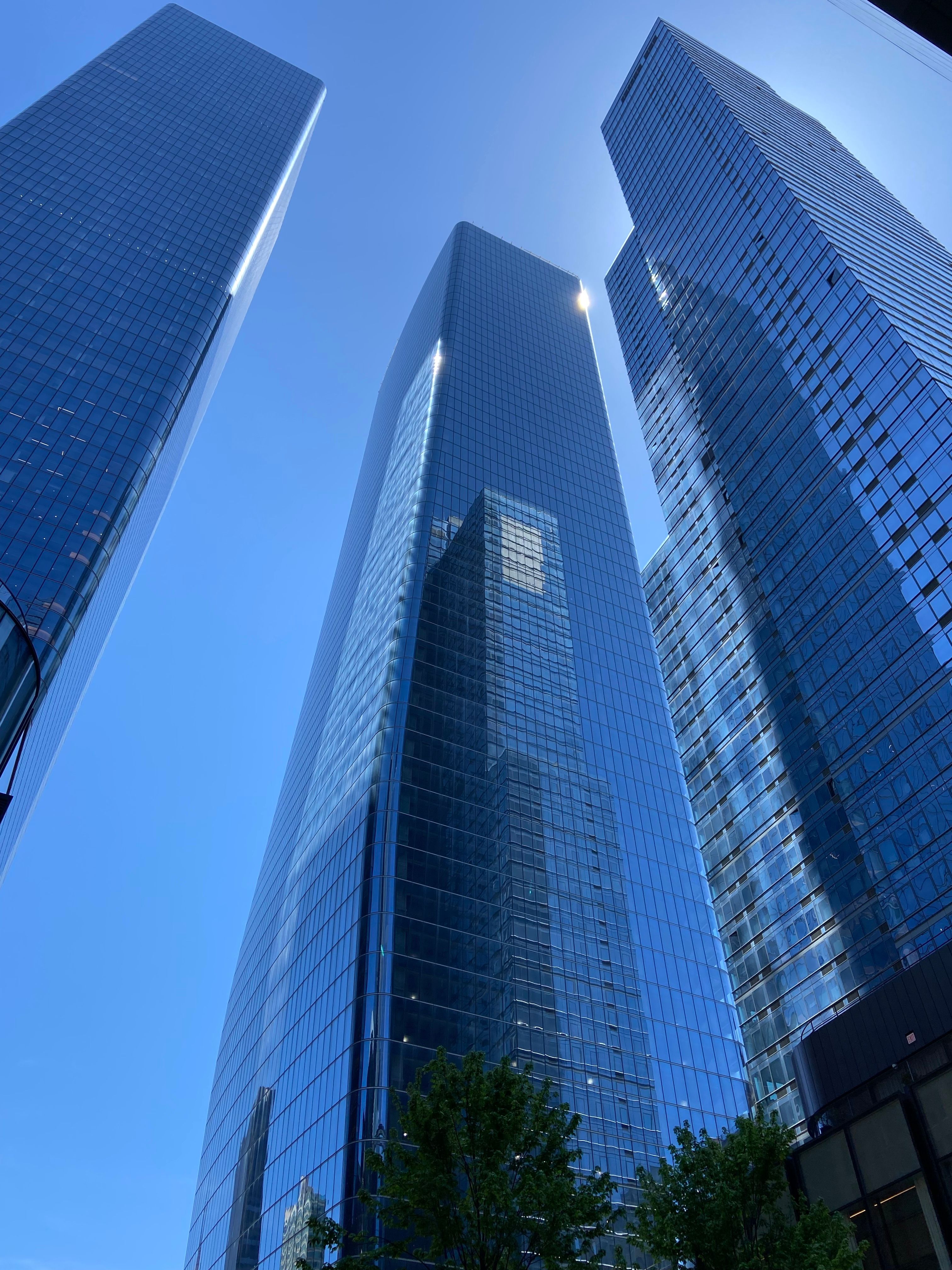 Three tall buildings are shown in a city · Free Stock Photo