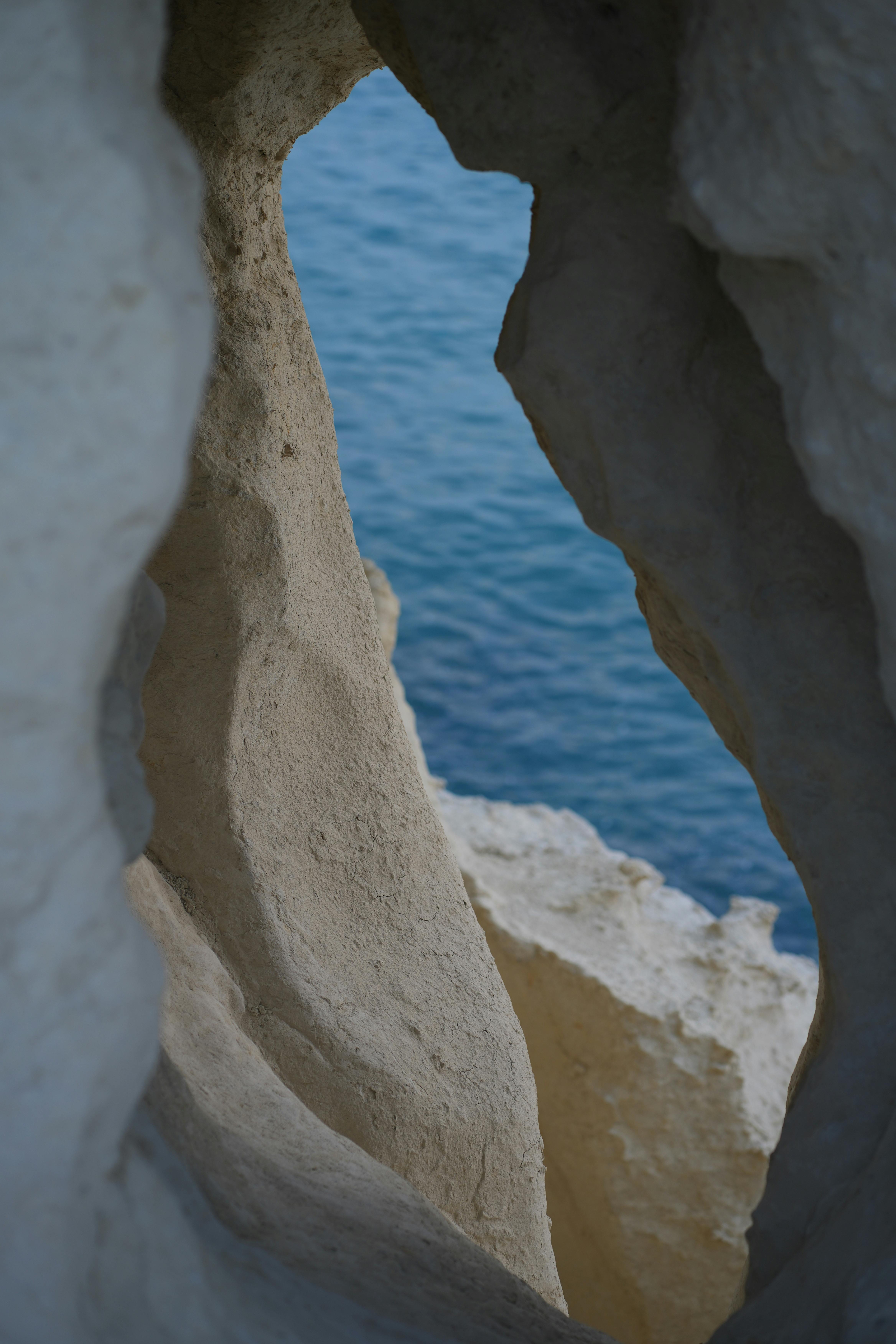 View on the Sea Through the Rocks · Free Stock Photo