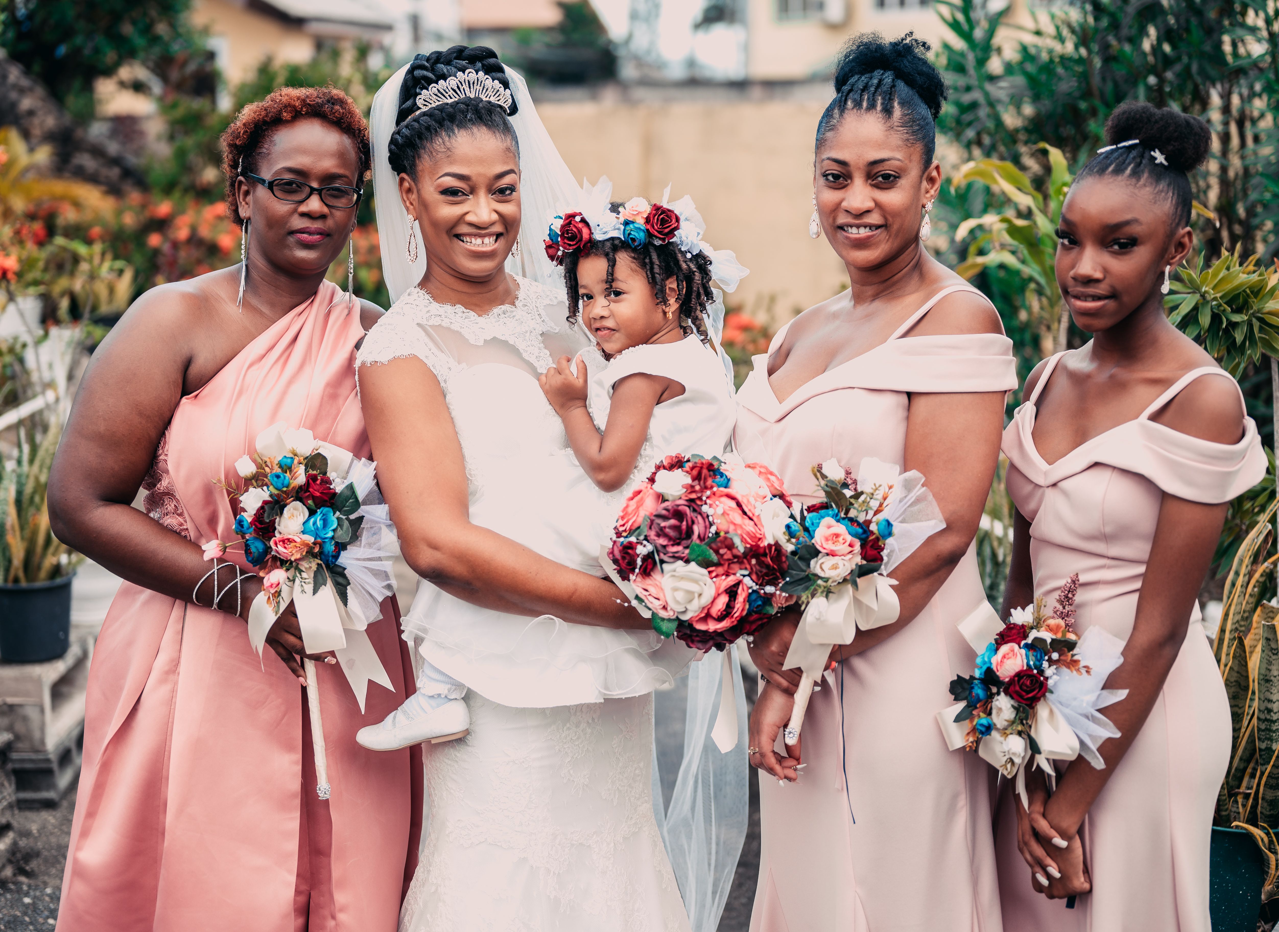 A bride and her bridesmaids pose for a photo · Free Stock Photo