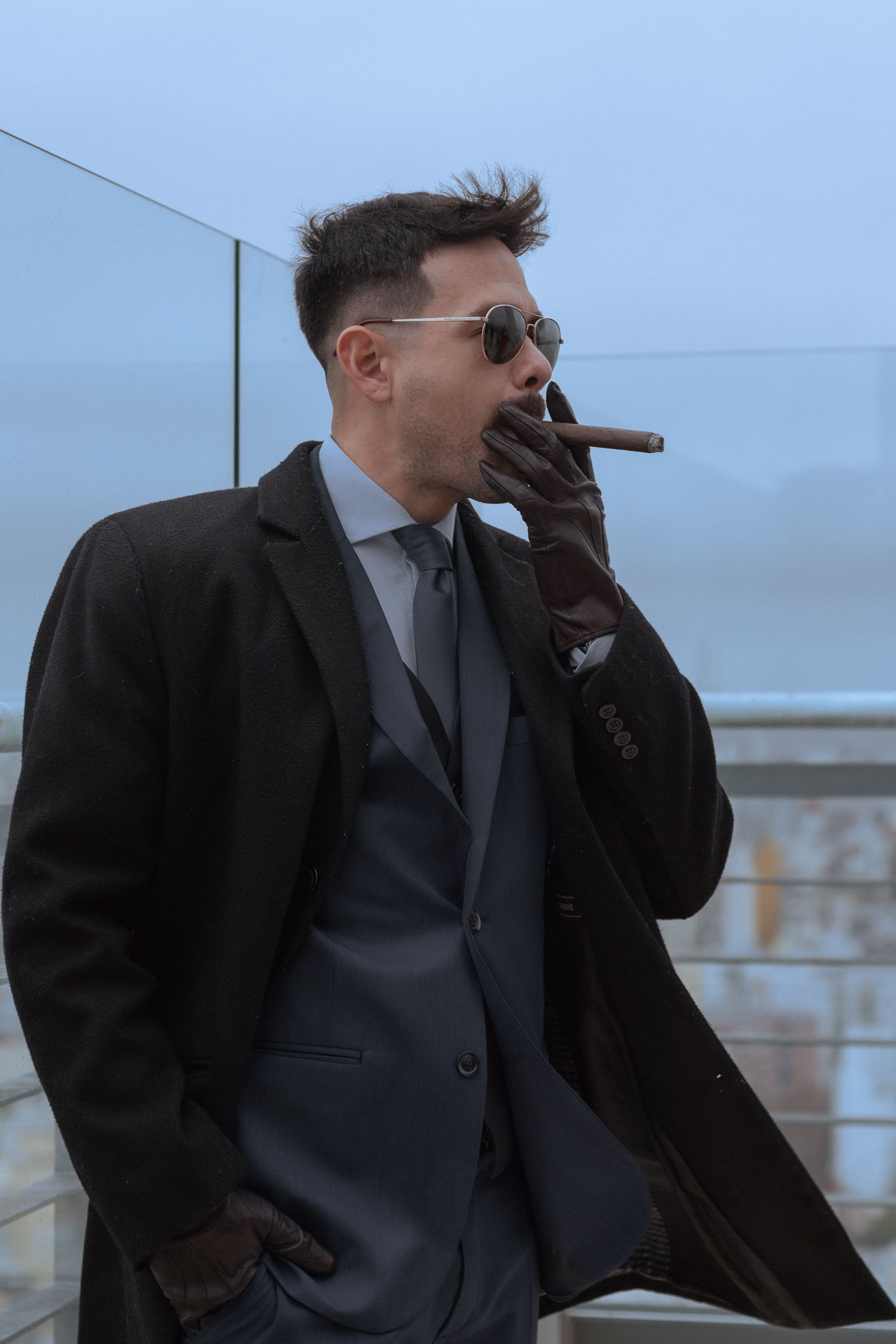 A man in a suit and tie smoking a cigar · Free Stock Photo