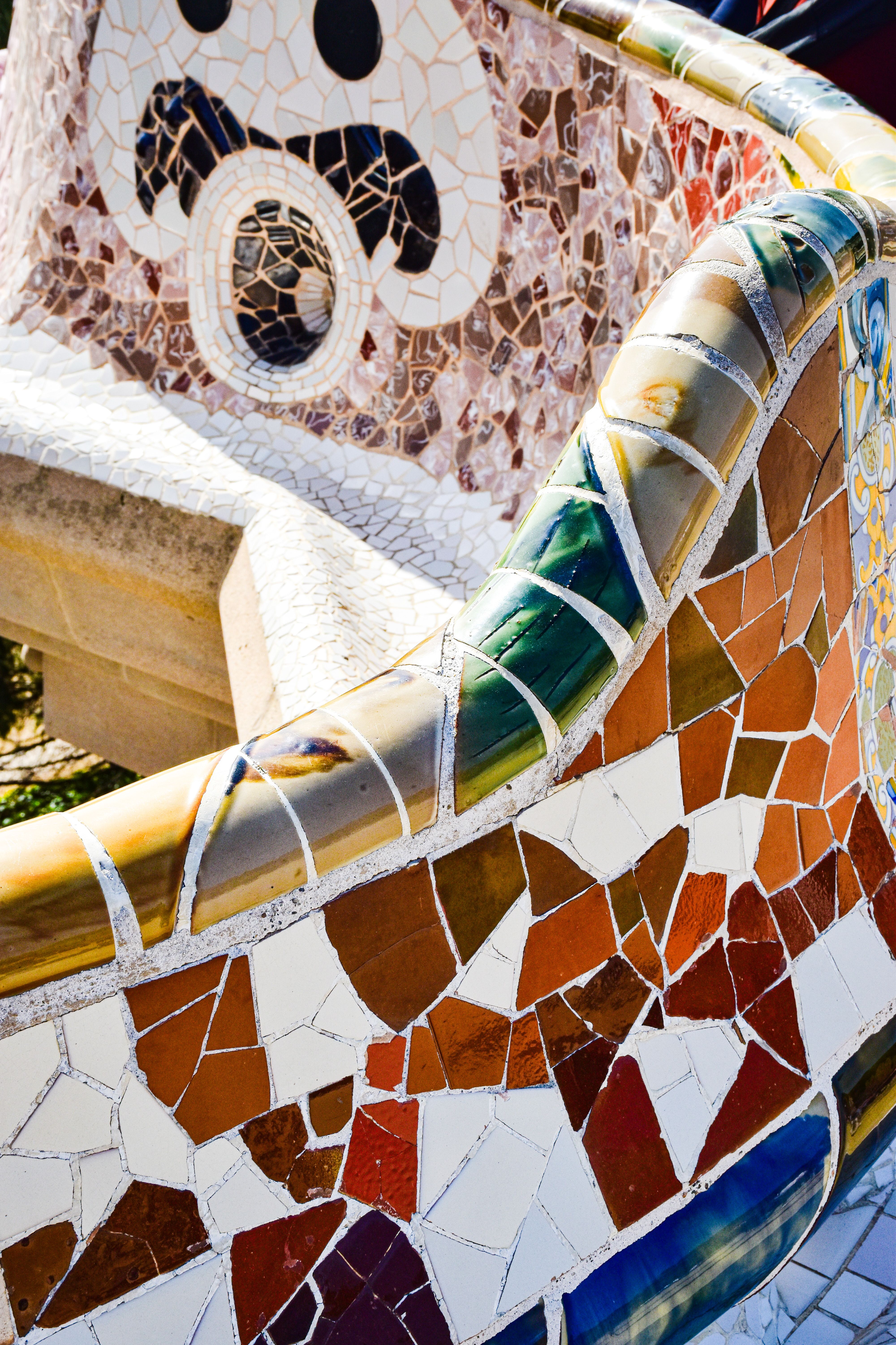 A close up of a mosaic bench with colorful designs · Free Stock Photo