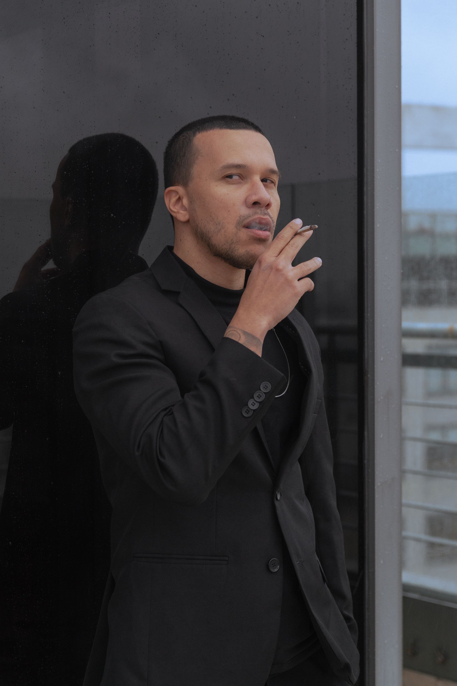 Man in Black Suit Smoking Cigarette · Free Stock Photo