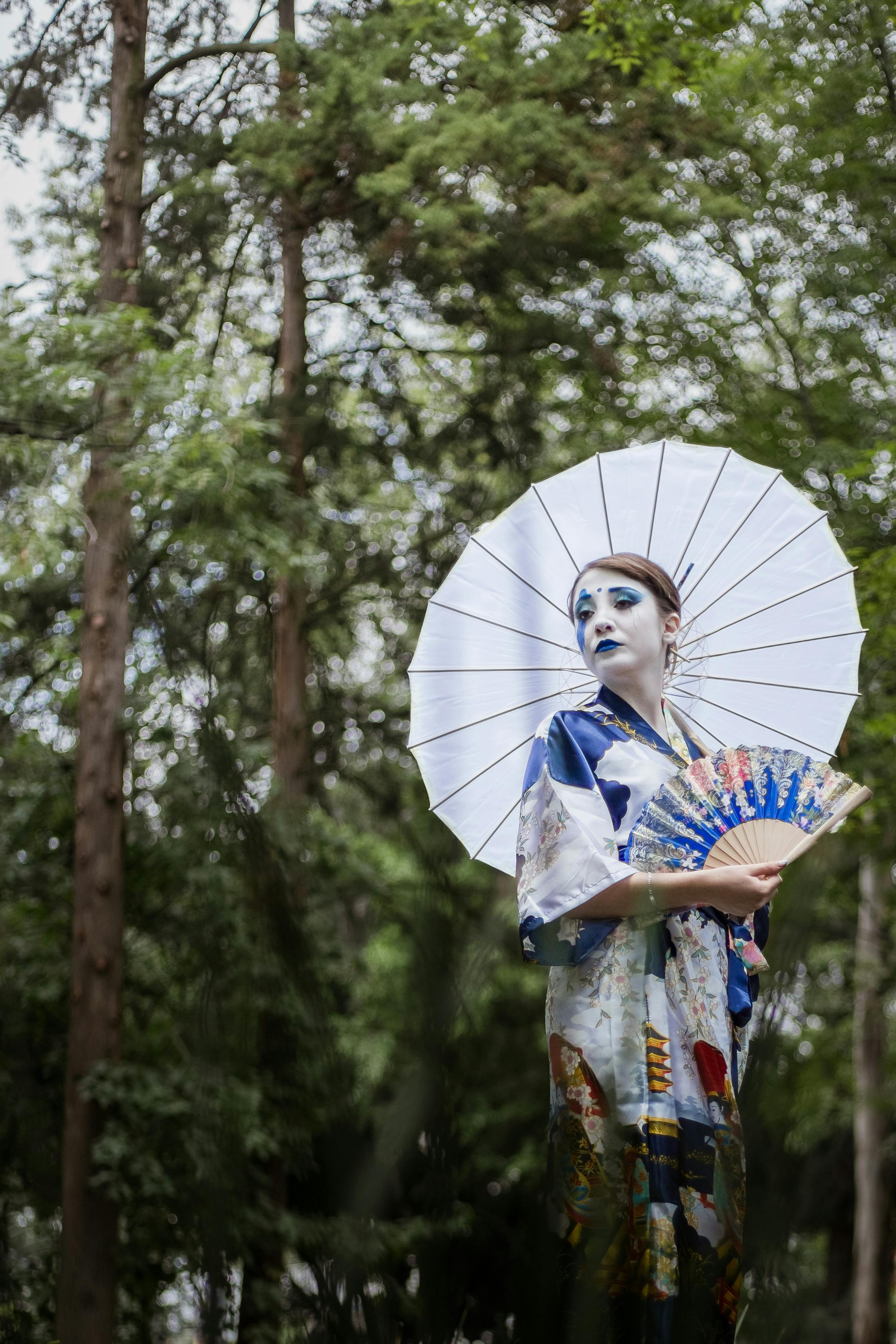 A Woman Dressed as a Geisha Posing in a Park · Free Stock Photo
