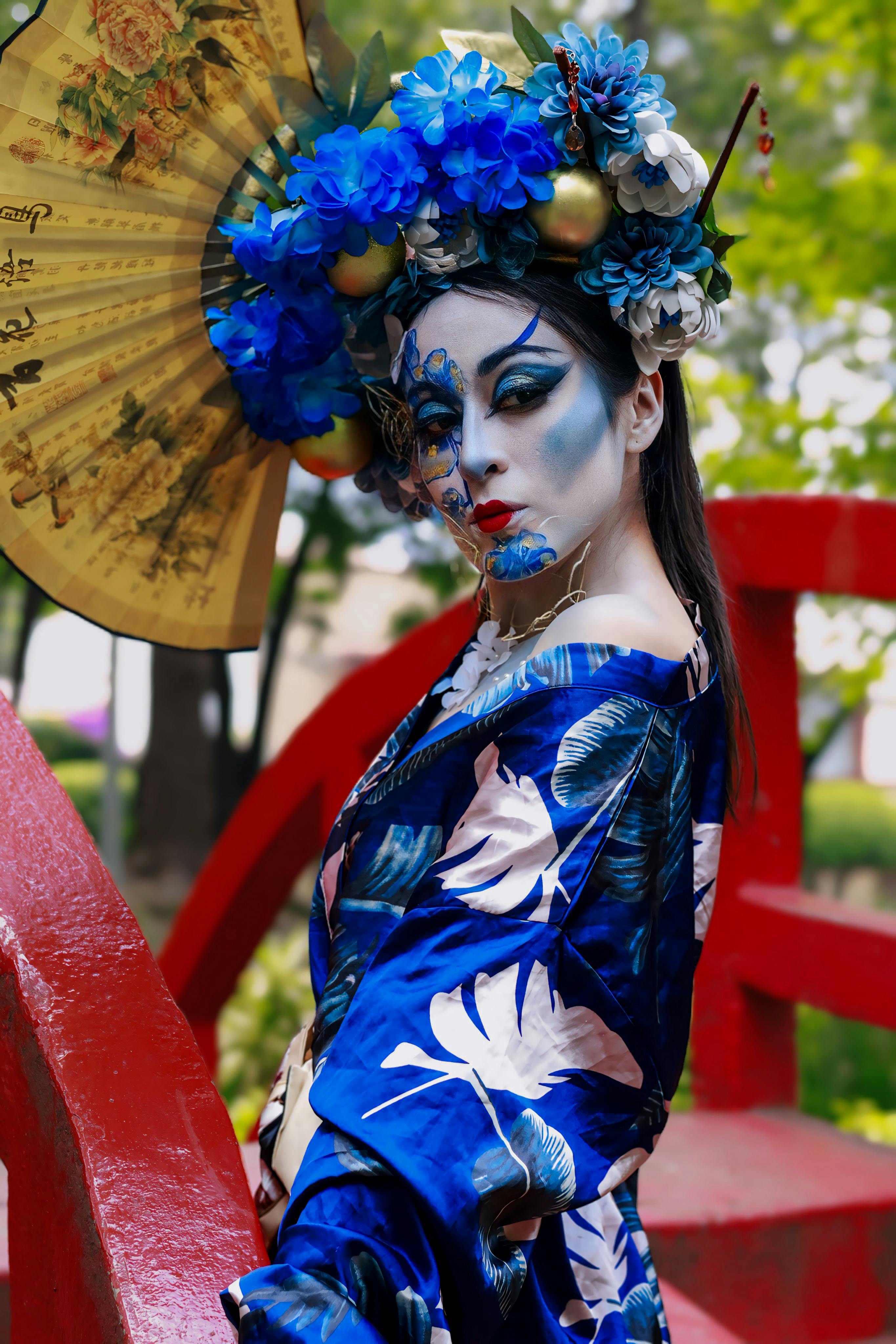 A Woman Dressed as a Geisha Posing in a Garden · Free Stock Photo