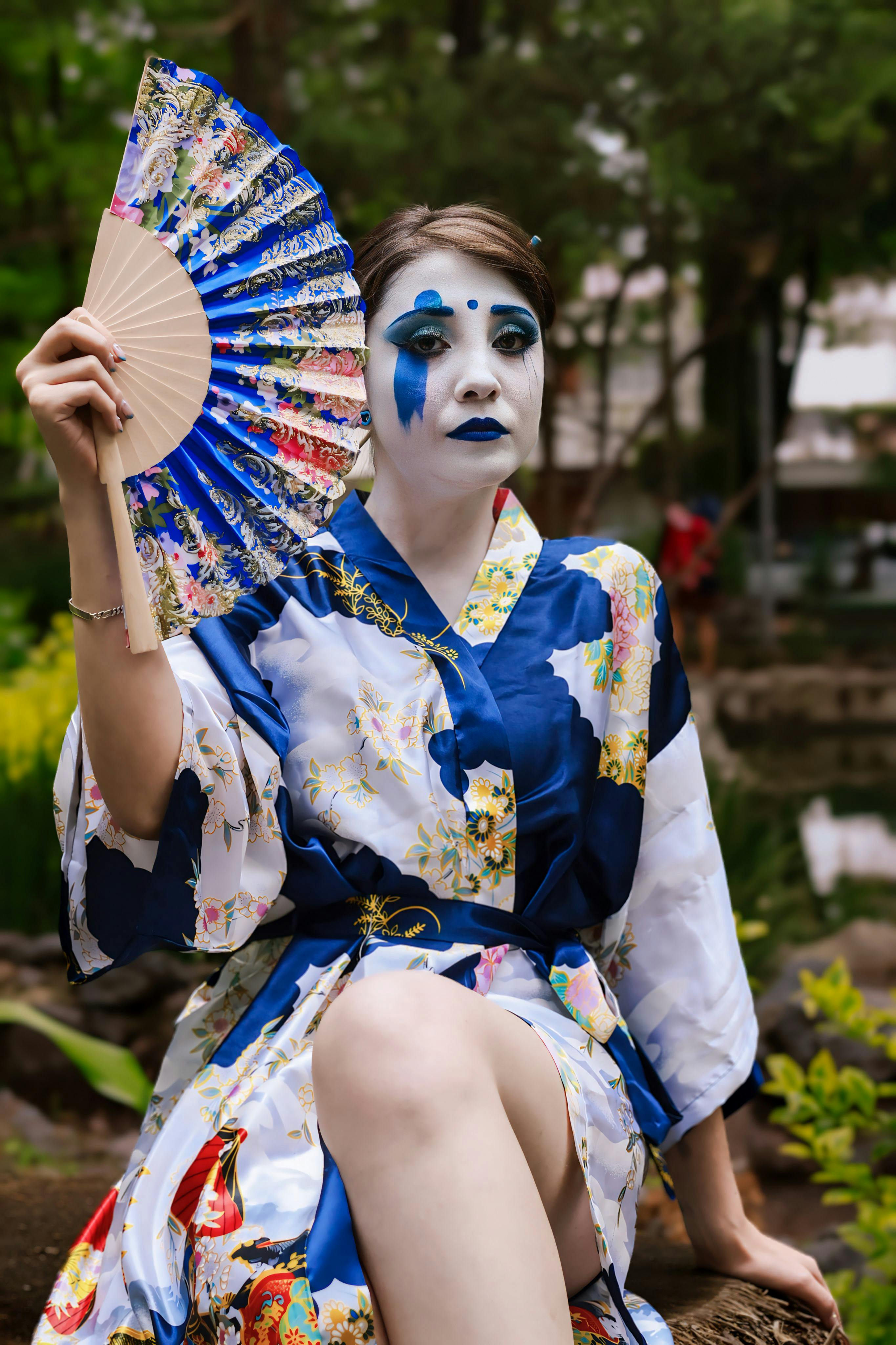 Woman Holding White and Brown Hand Fan · Free Stock Photo