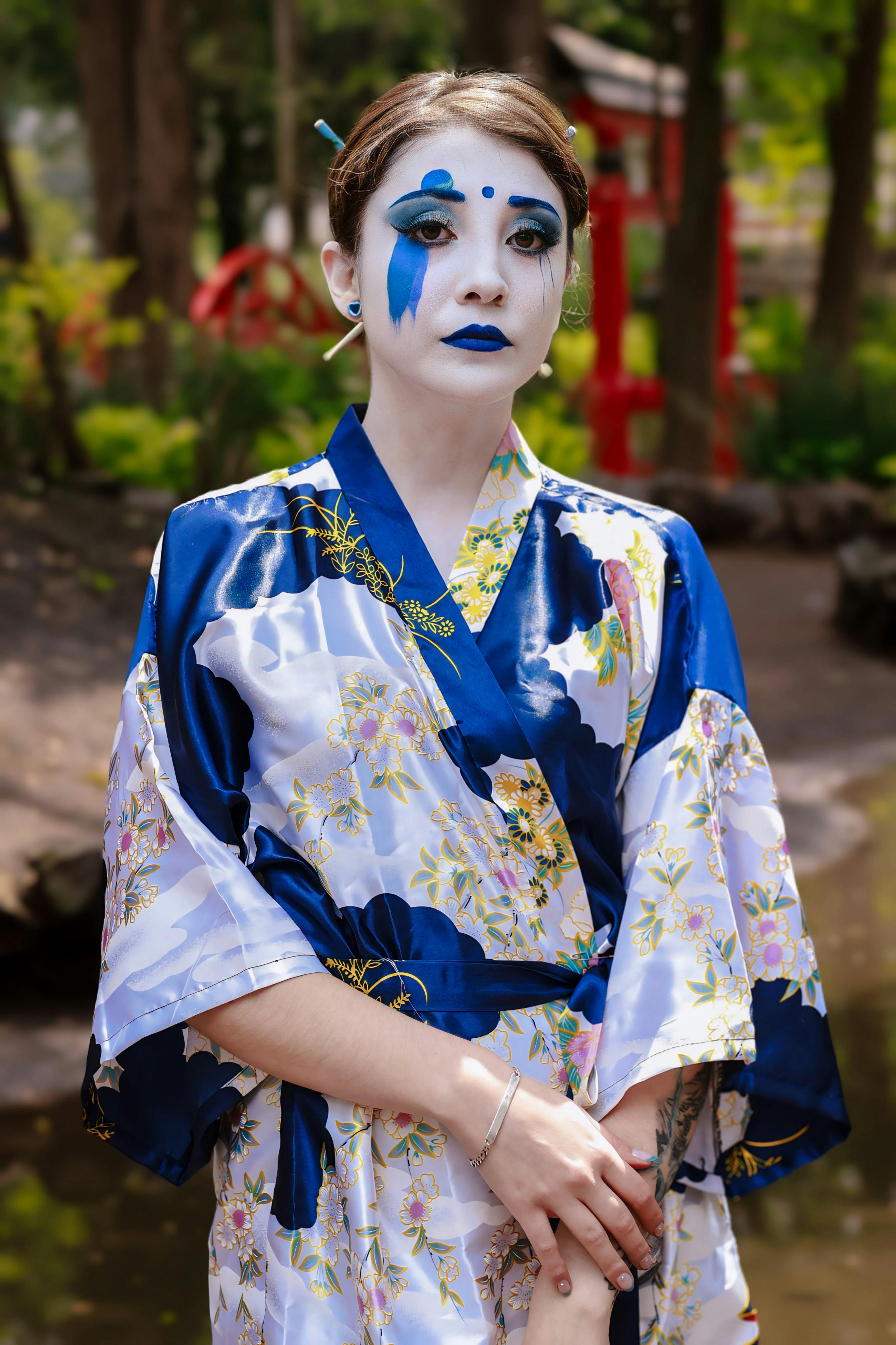A woman in a geisha costume with blue face paint · Free Stock Photo