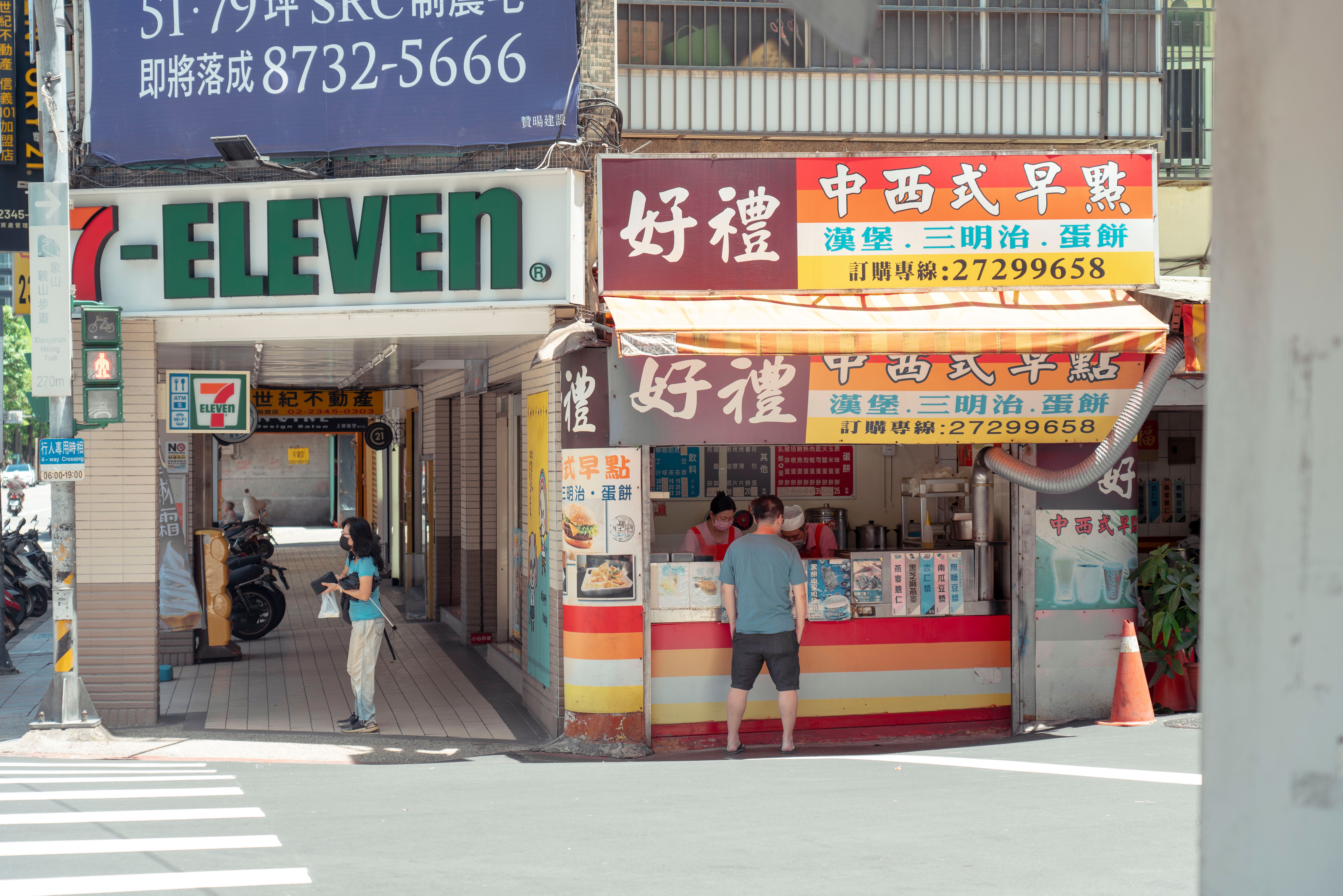 A man walking down the street in front of a chinese restaurant · Free ...