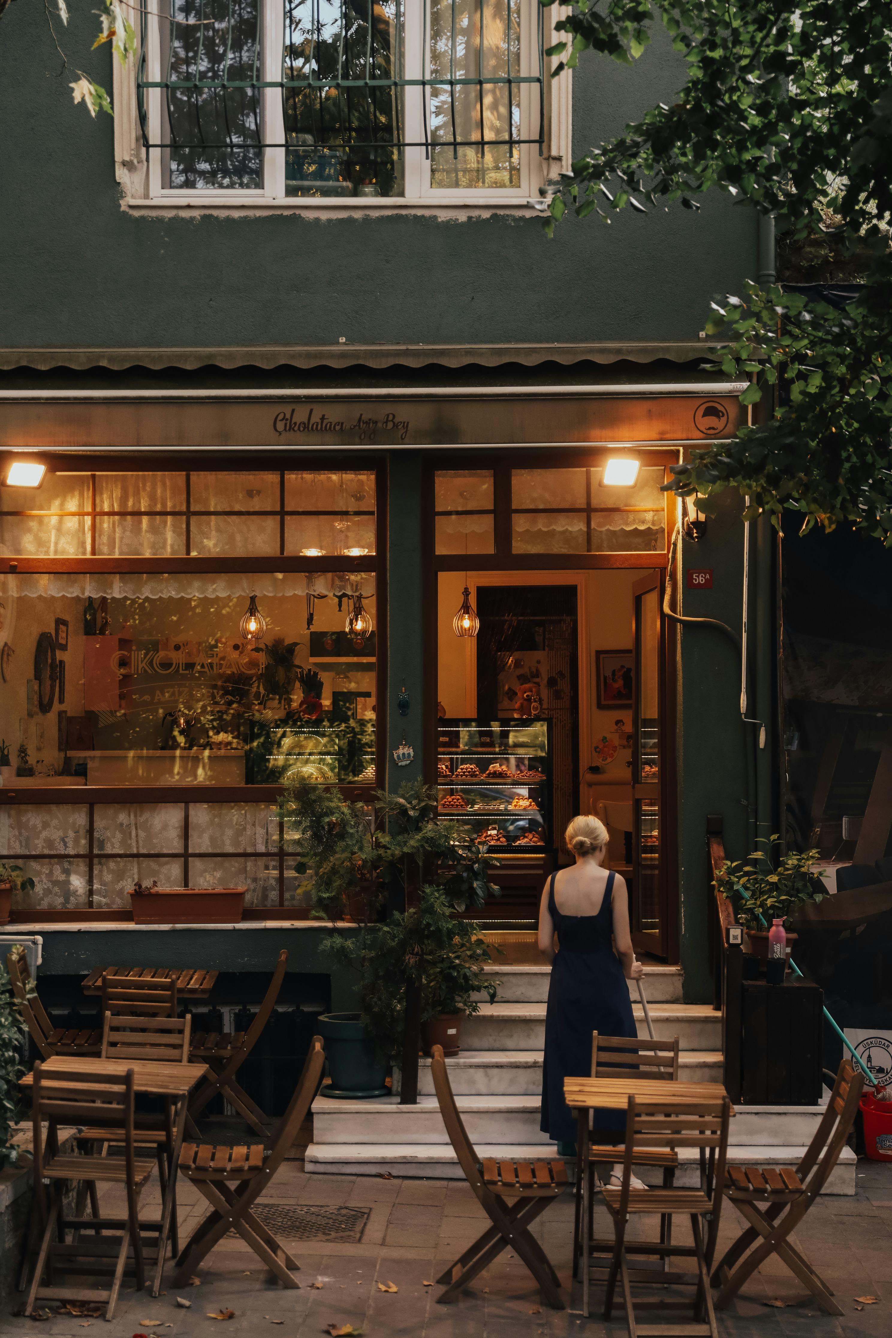 Back View of a Woman Entering a Restaurant · Free Stock Photo