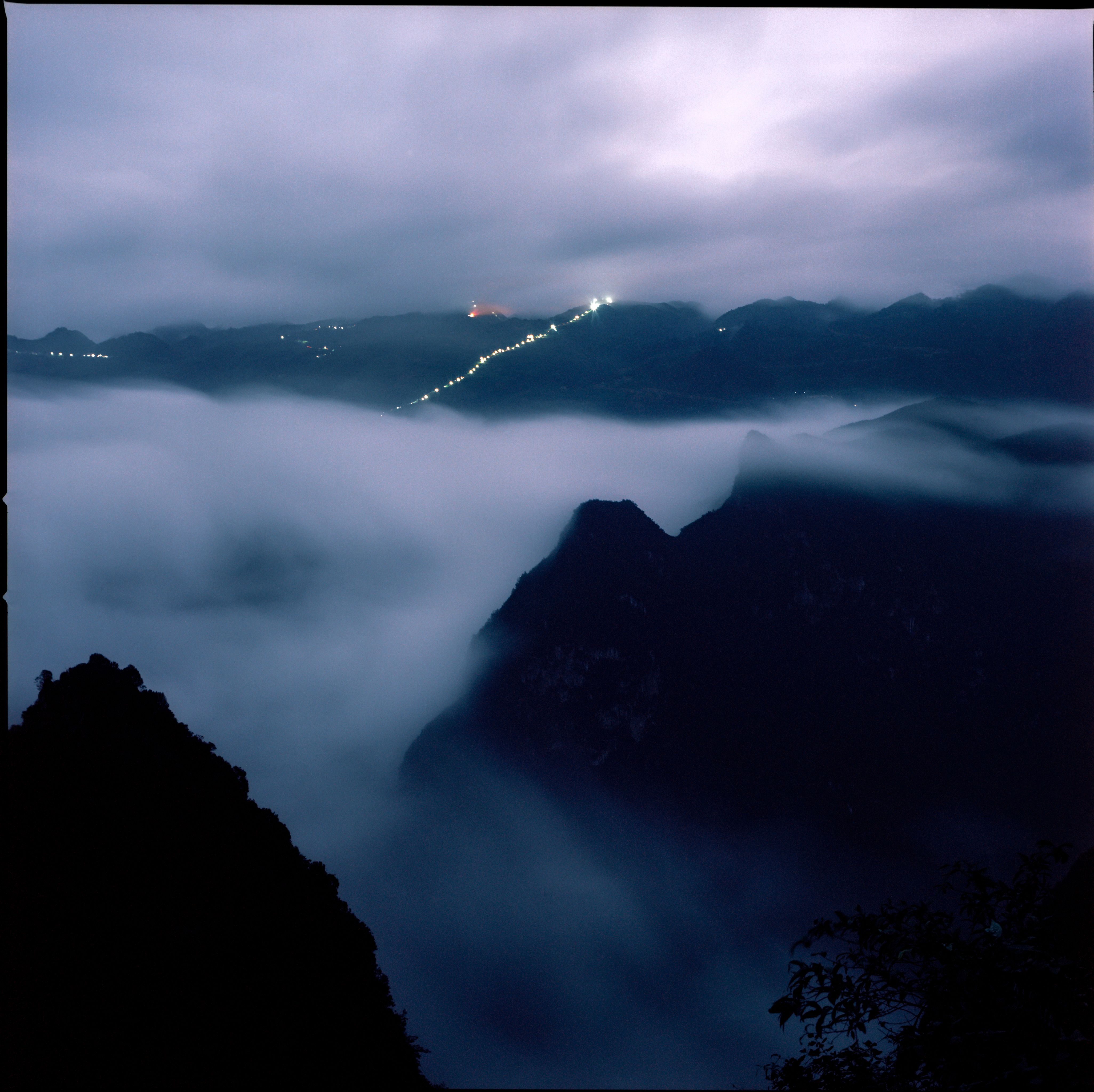 Aerial View of Silhouetted Mountains under Dark Clouds · Free Stock Photo