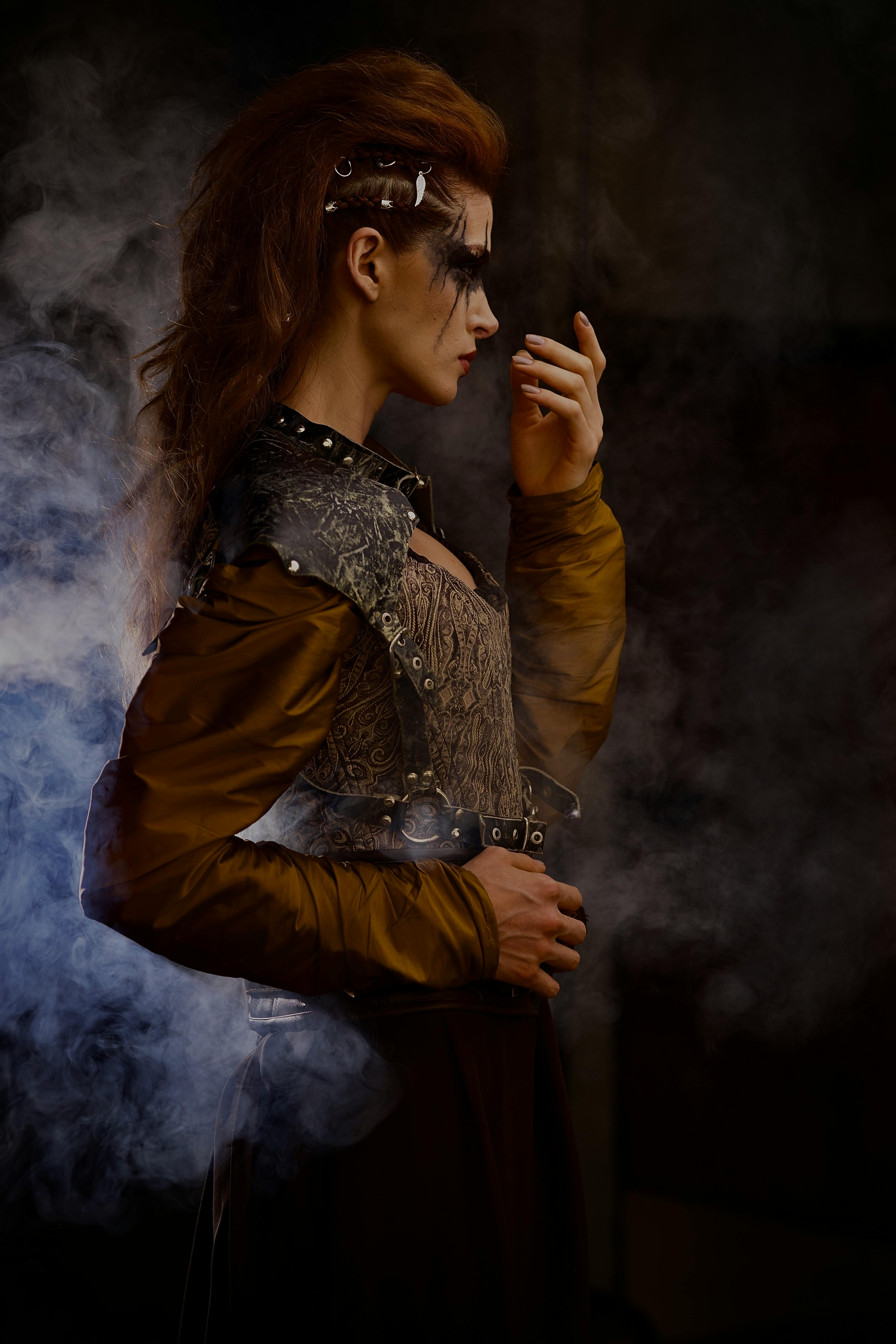 A woman in a medieval costume smoking · Free Stock Photo