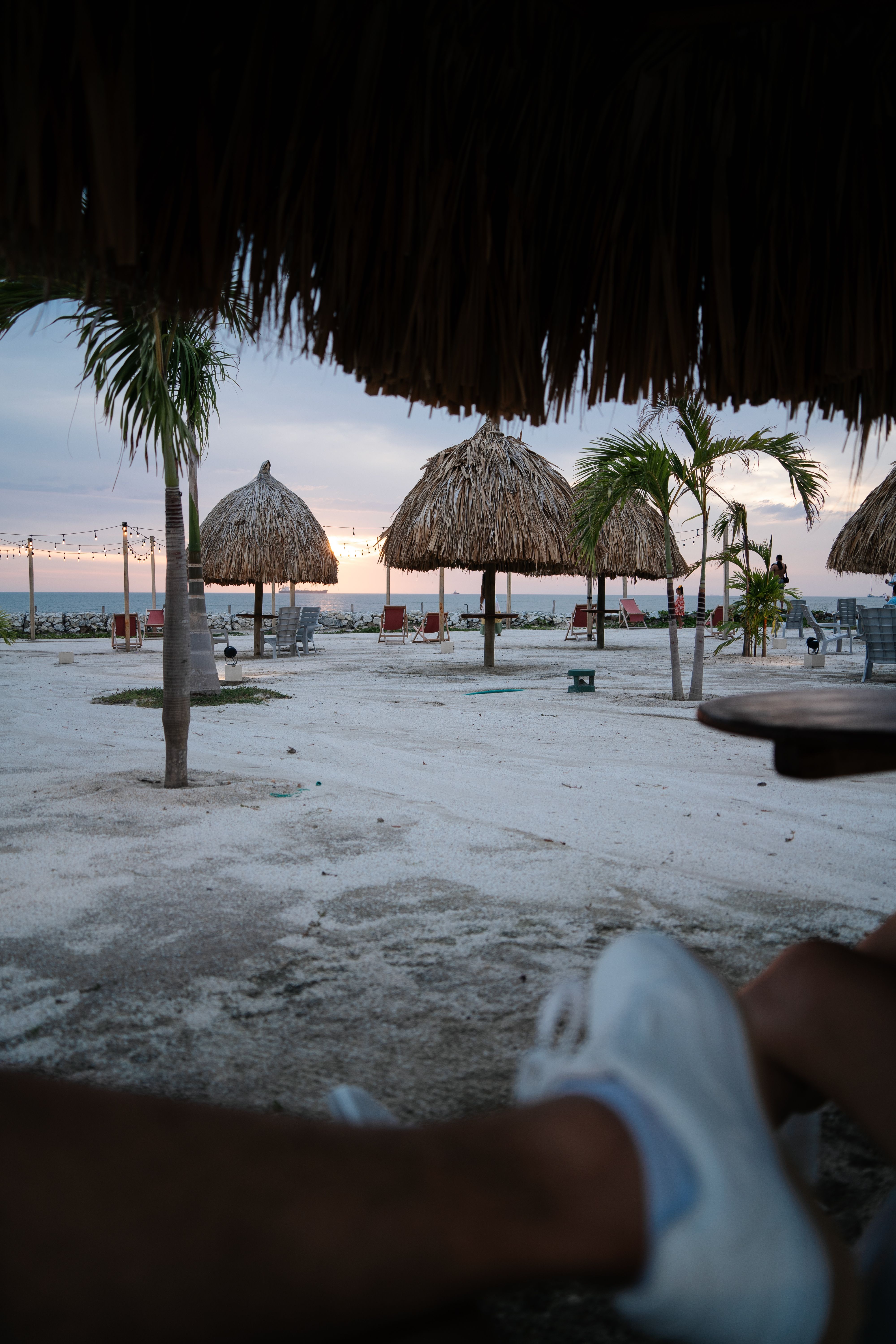 A person sitting on a beach with a view of the ocean · Free Stock Photo