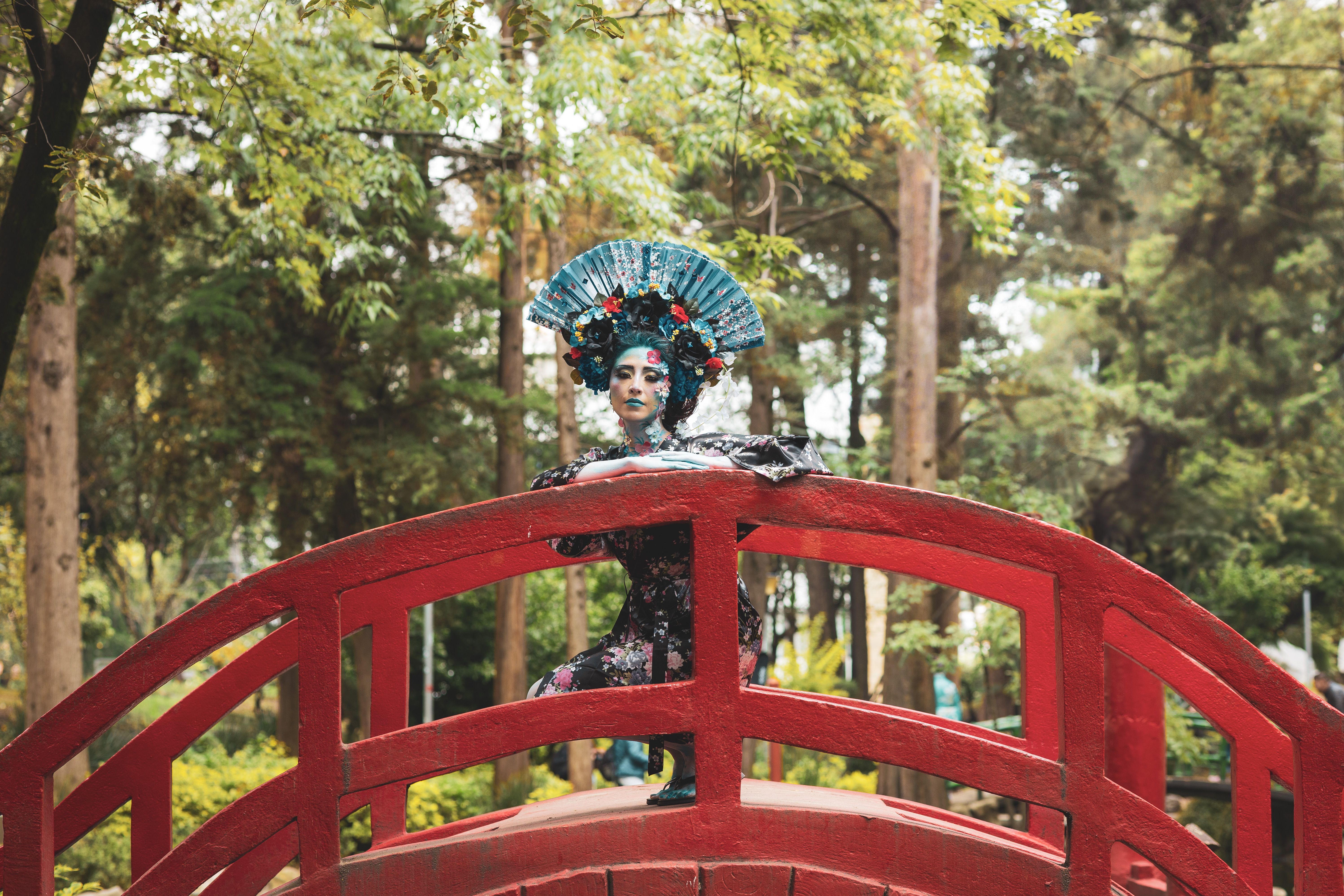 Geisha in Traditional Clothing Crouching on Footbridge · Free Stock Photo