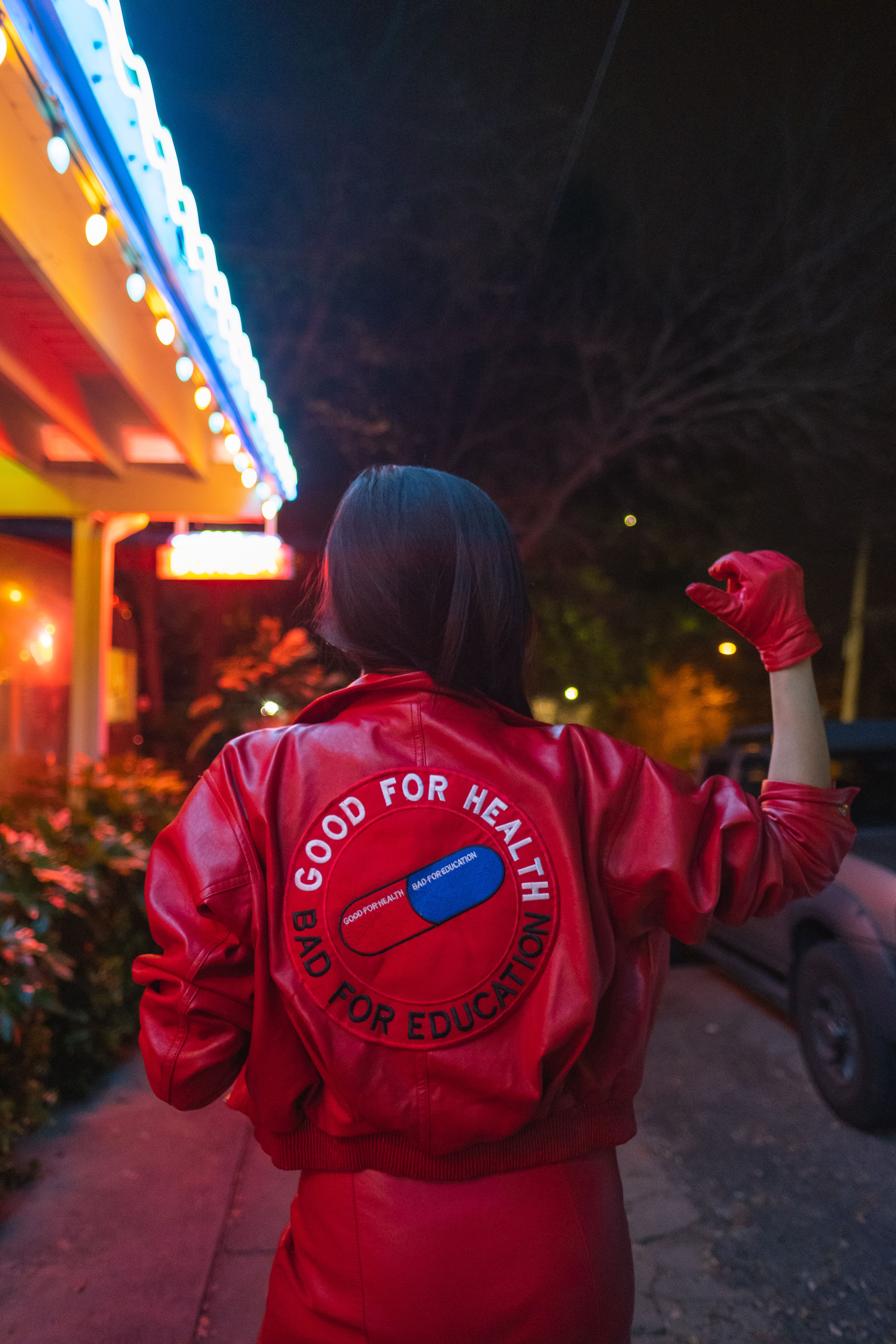 Woman Standing in Red Jacket with Pill · Free Stock Photo