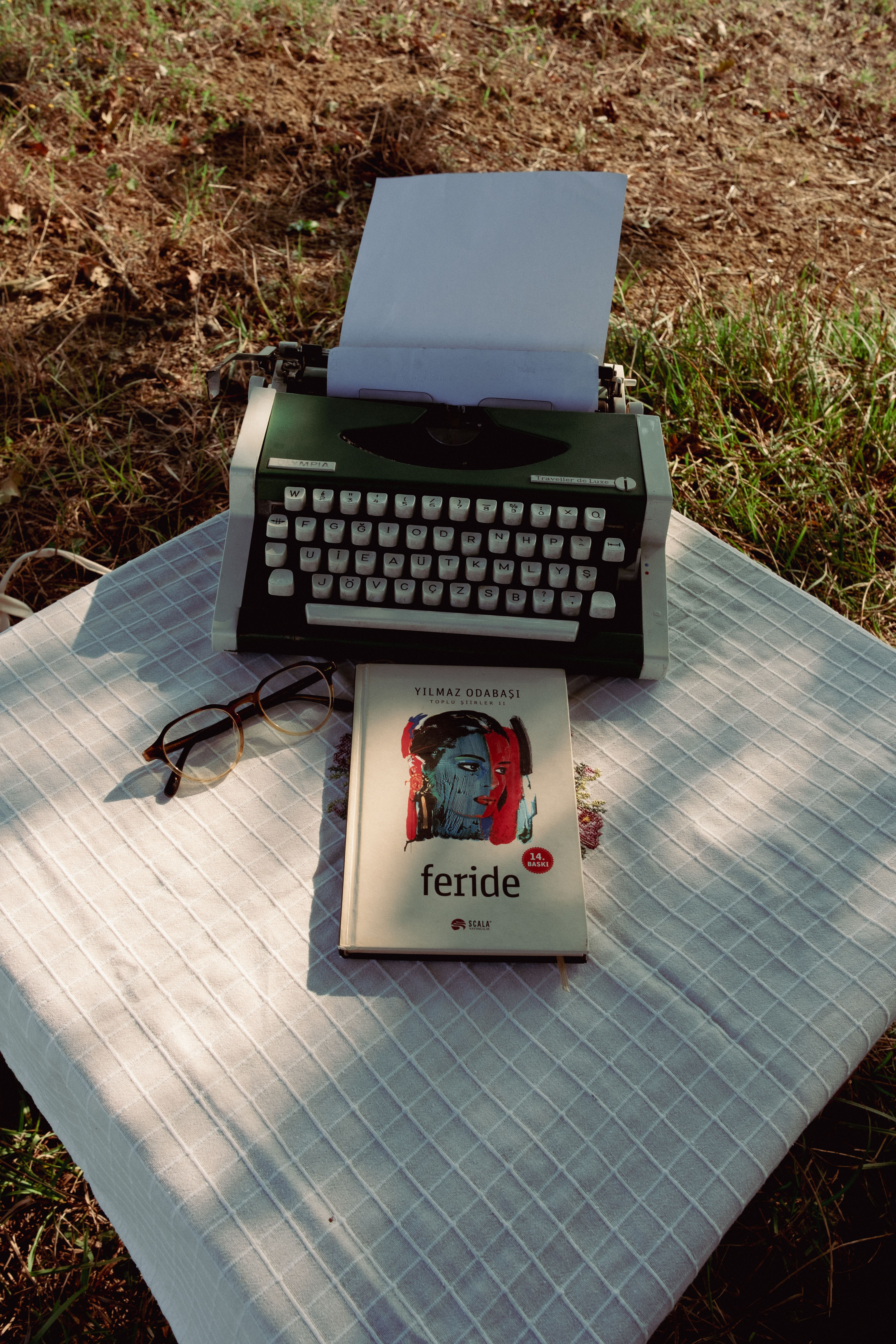 A typewriter and a book on a table · Free Stock Photo
