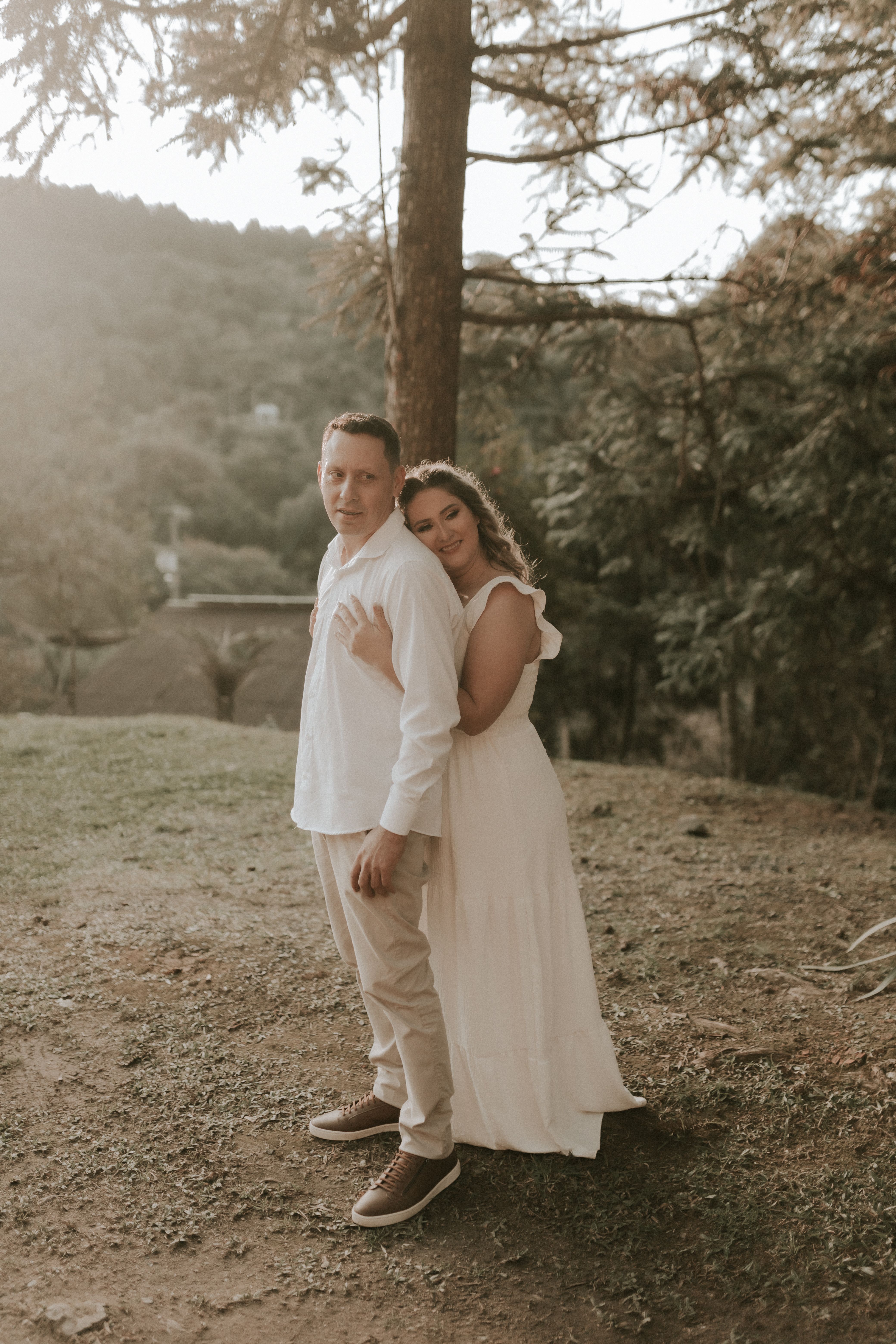 A couple standing in the woods during their engagement session · Free ...