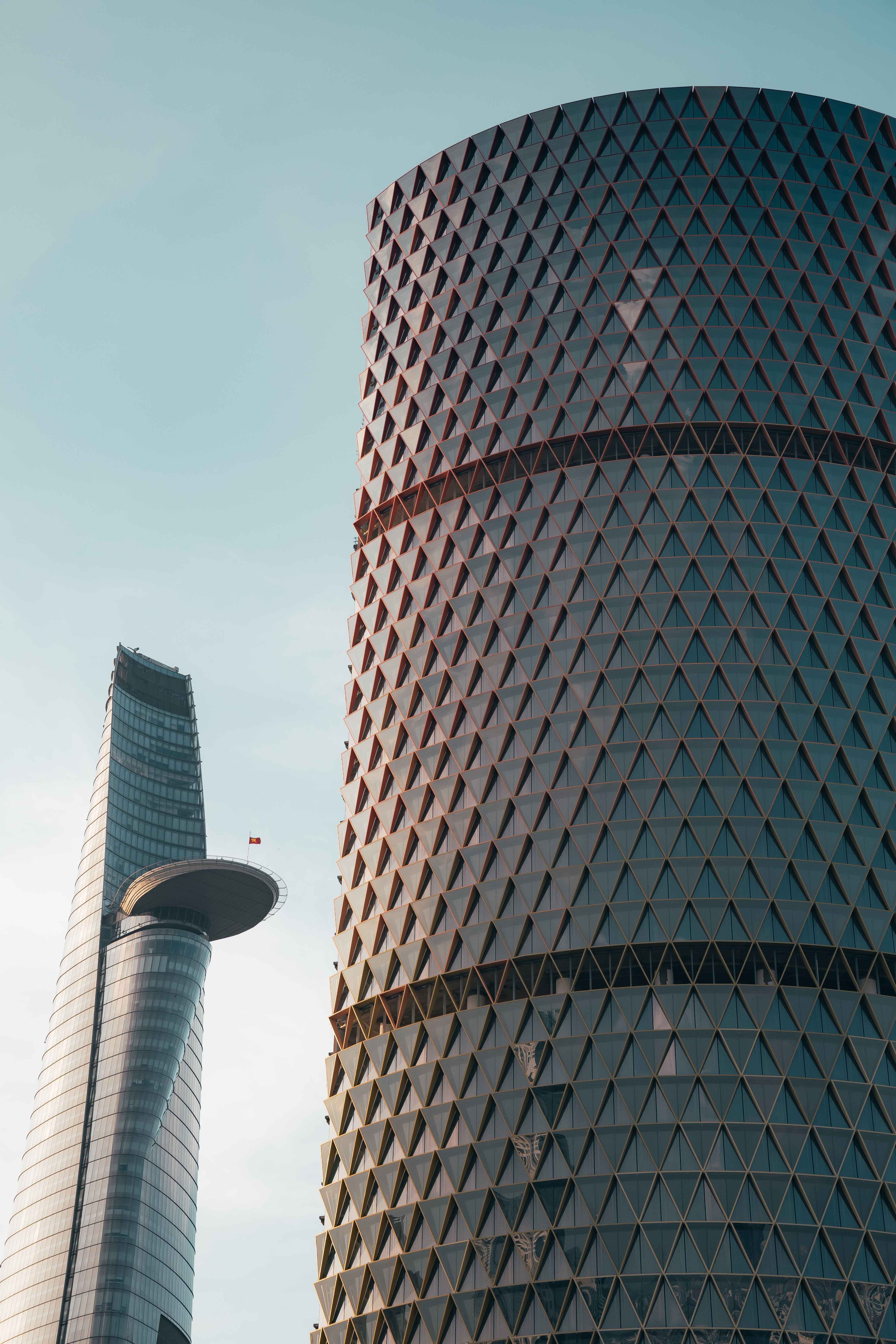 A tall building with a large glass structure · Free Stock Photo