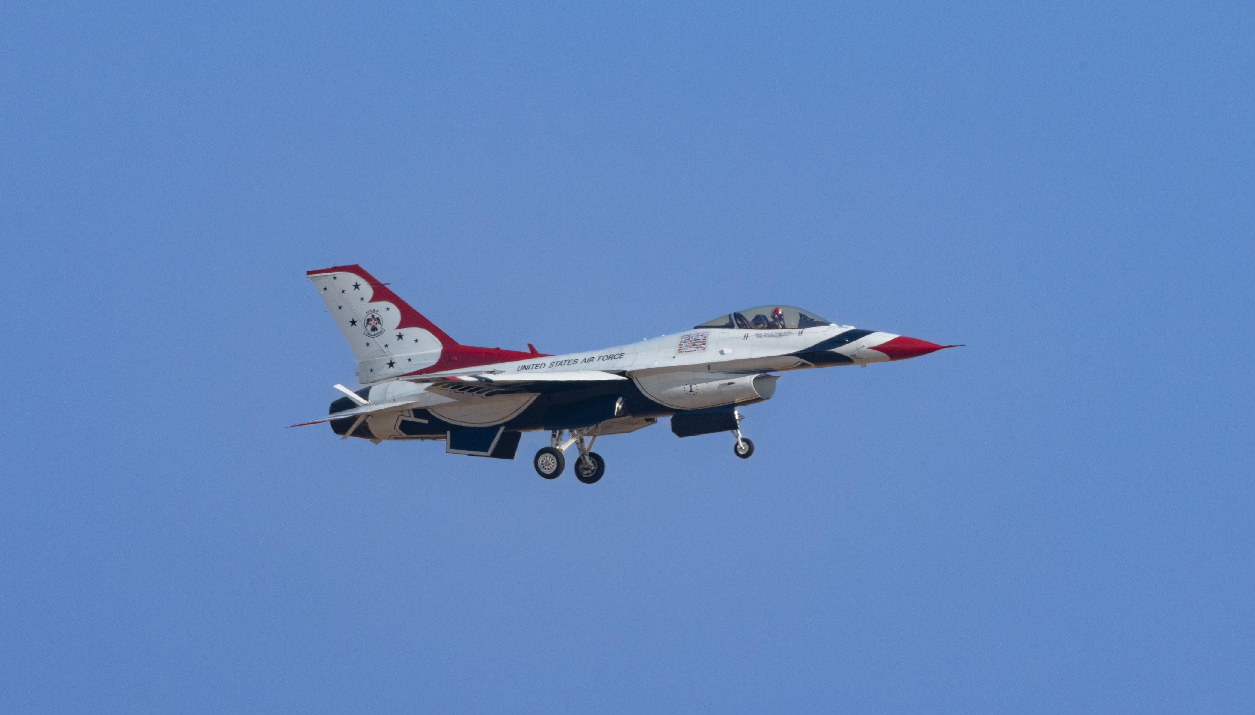 A fighter jet flying through the air with a red and white tail · Free ...