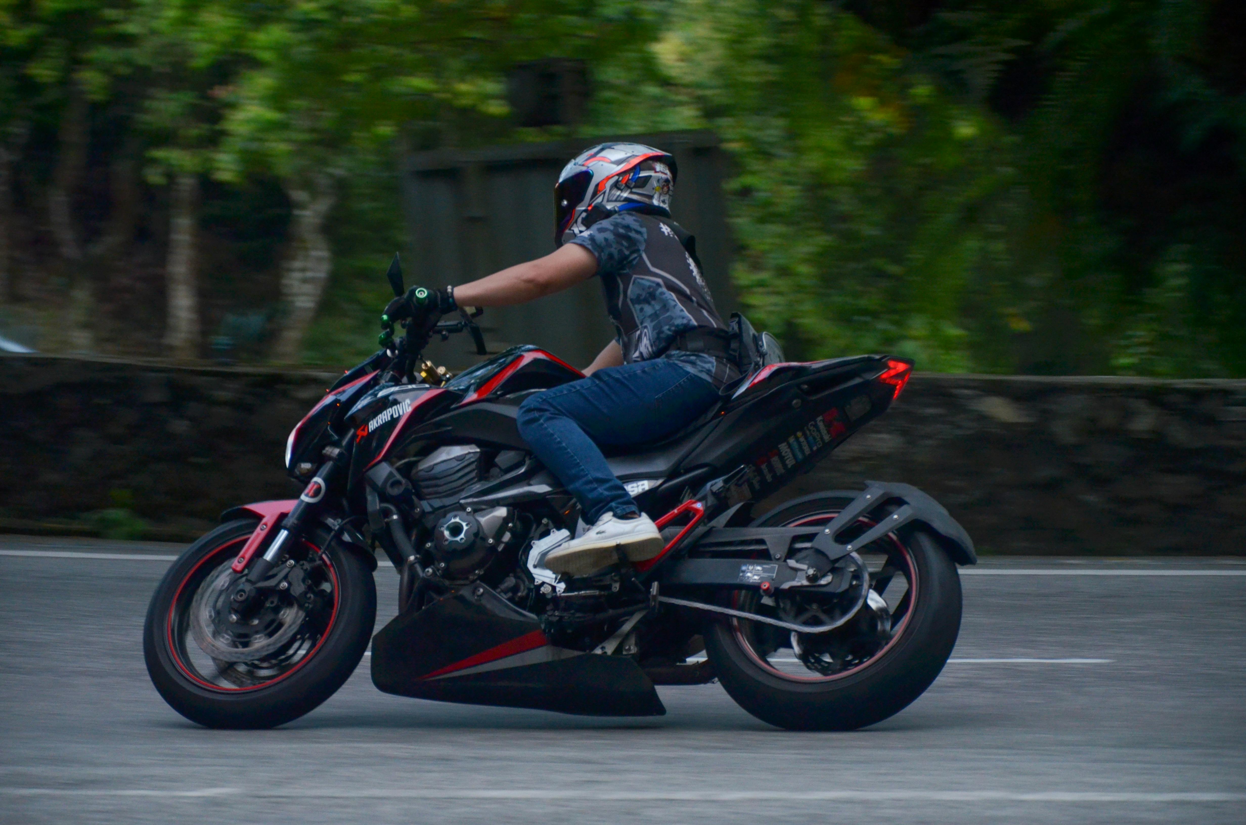 Black Backbone Motorcycle Near Man in Blue Shirt at Daytime · Free ...