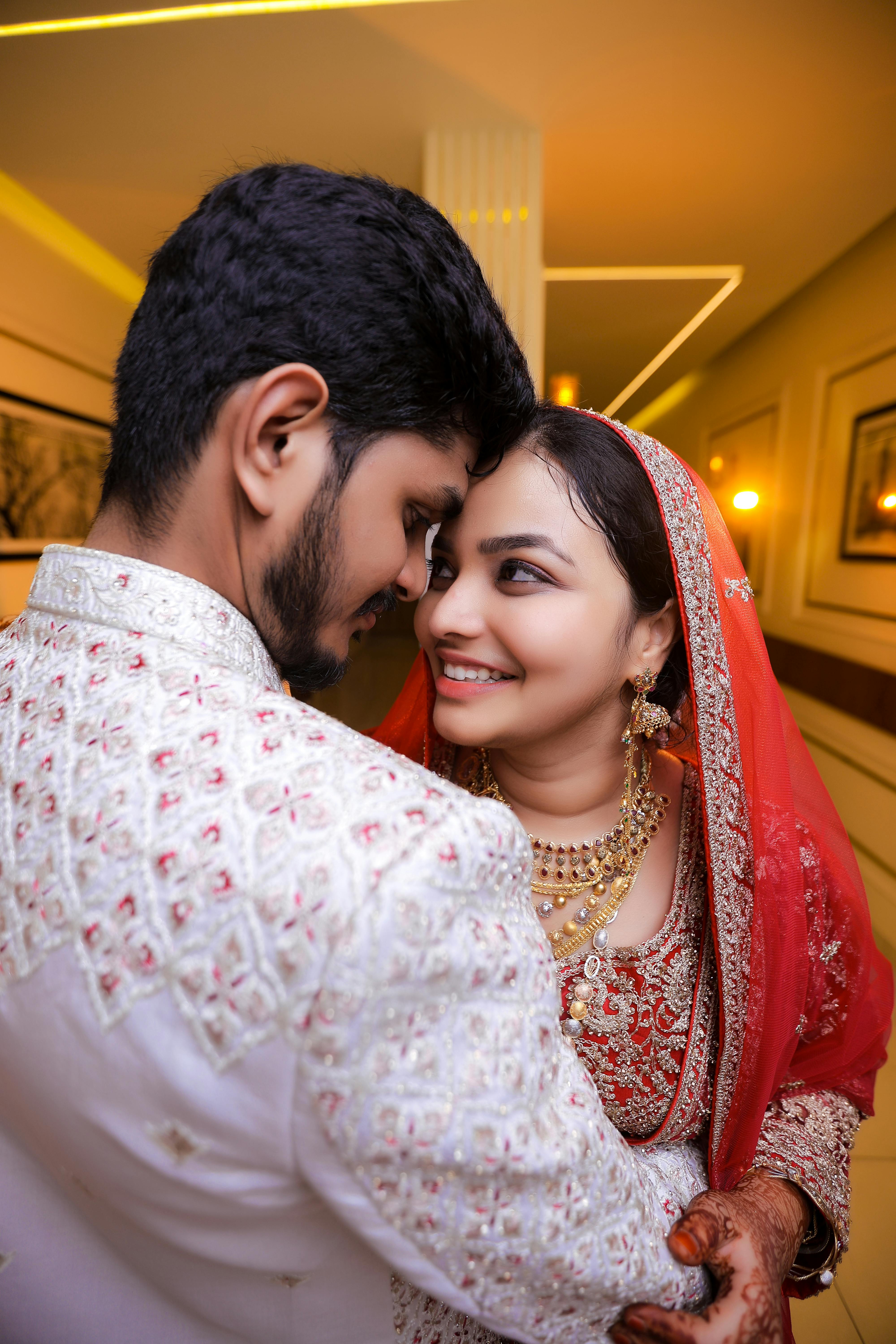 A couple in traditional attire posing for a photo · Free Stock Photo