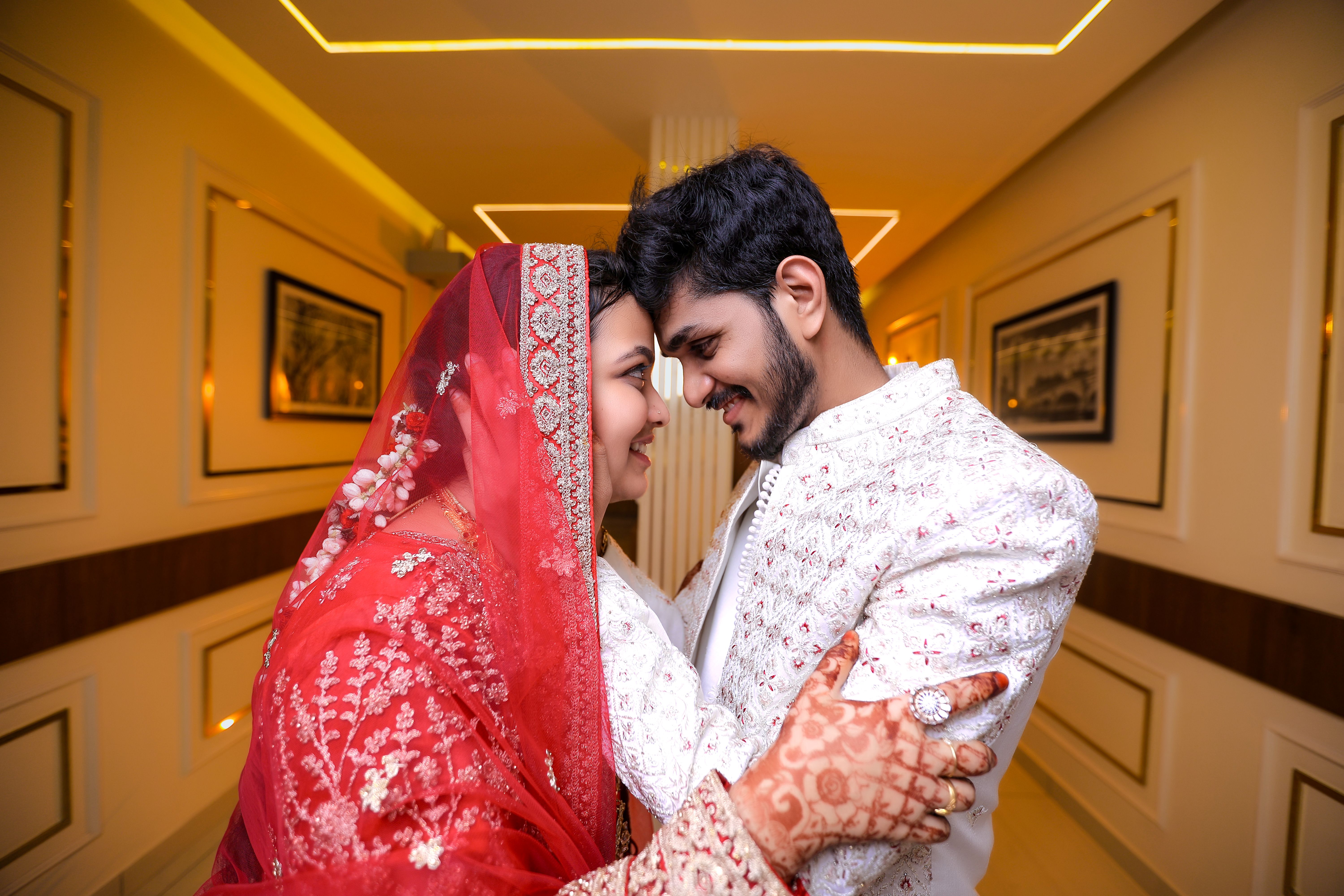 A couple in traditional attire hugging each other · Free Stock Photo
