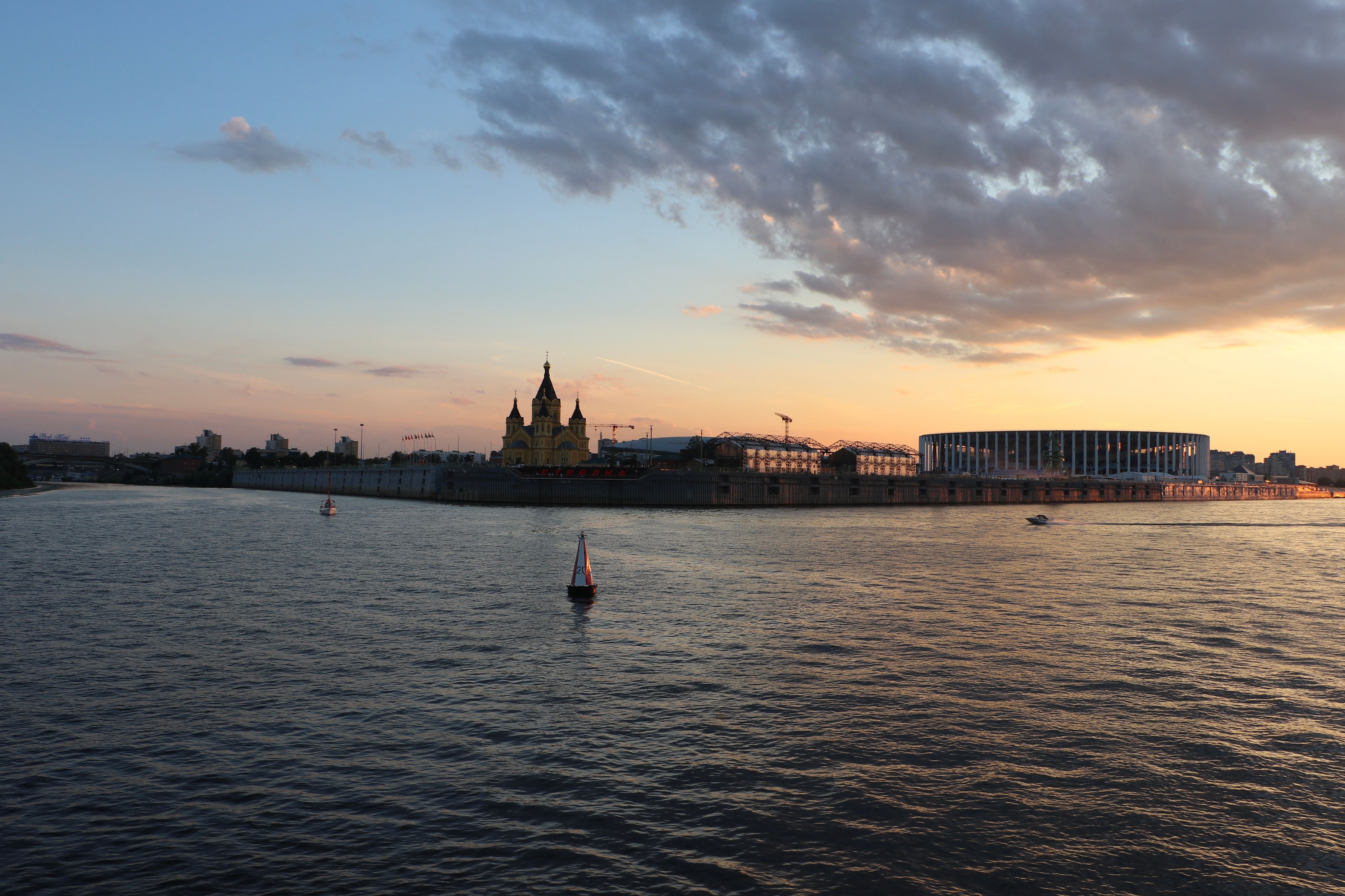 A boat is floating on the water at sunset · Free Stock Photo