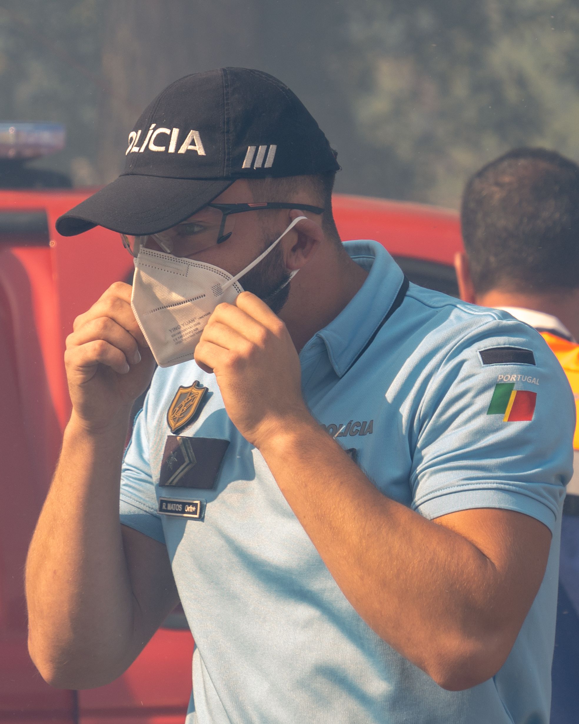 A man wearing a mask and holding a fire extinguisher · Free Stock Photo