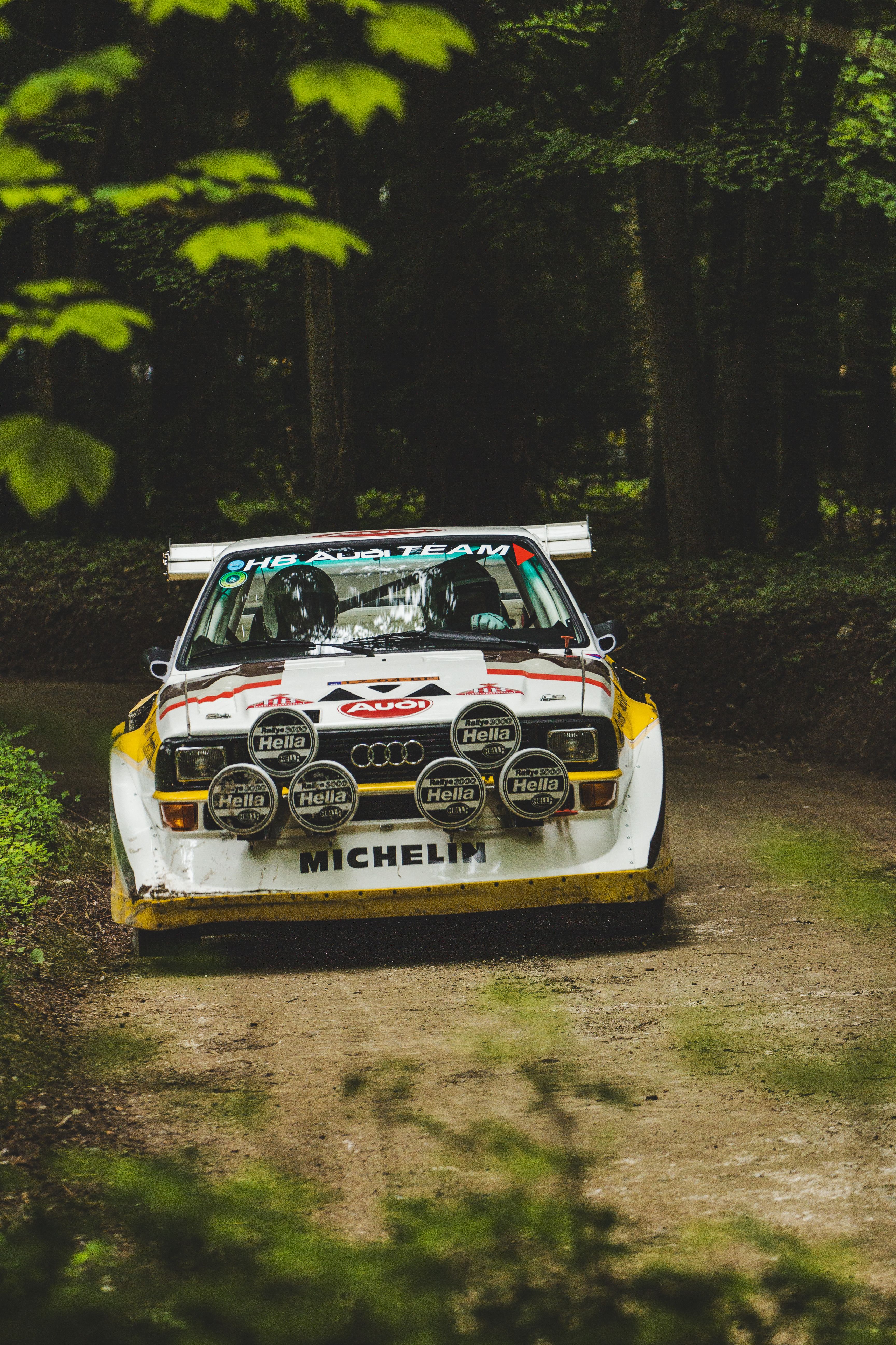 A rally car driving through the woods · Free Stock Photo