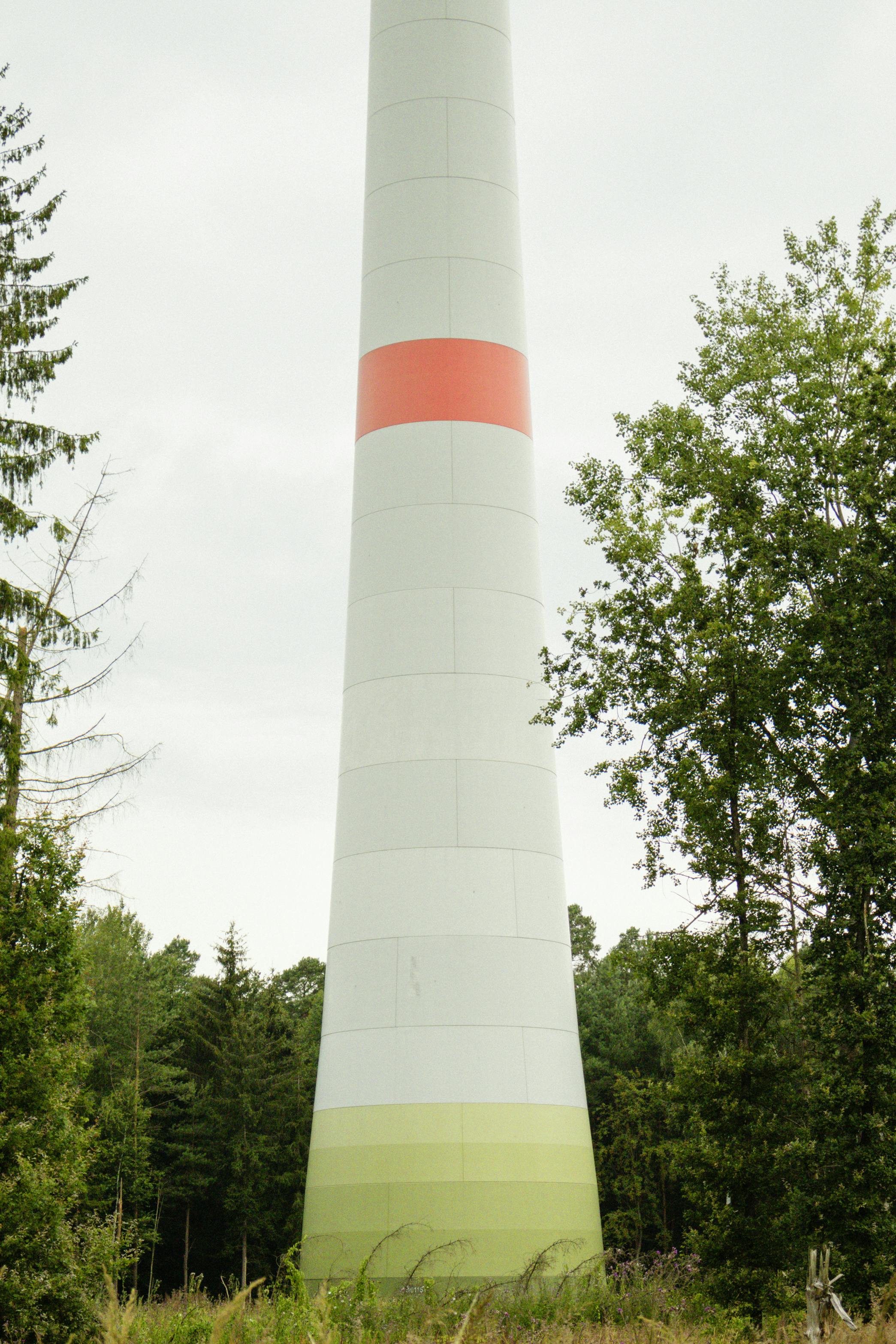 A tall white and red tower with a green stripe · Free Stock Photo