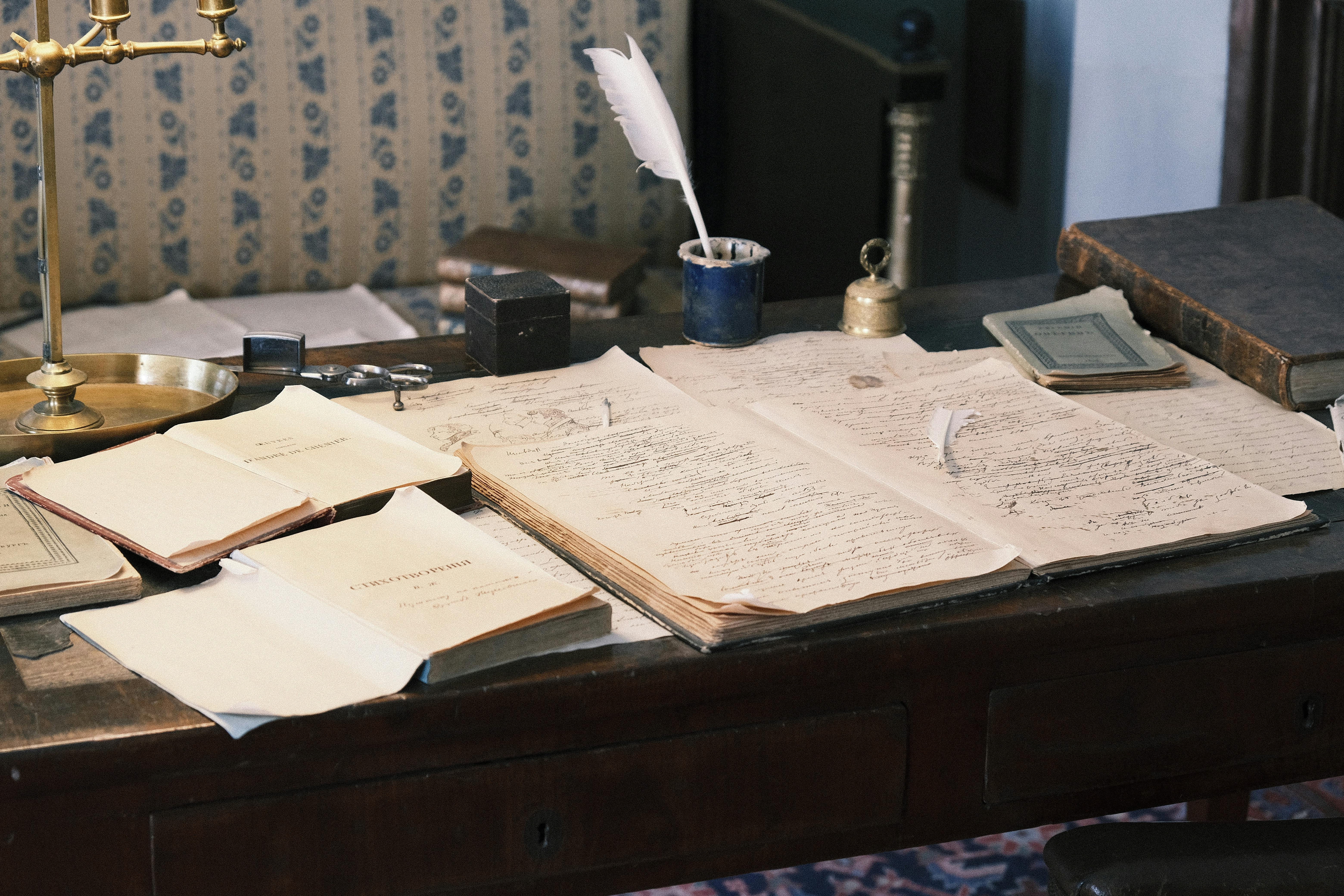 A desk with a book and papers on it · Free Stock Photo