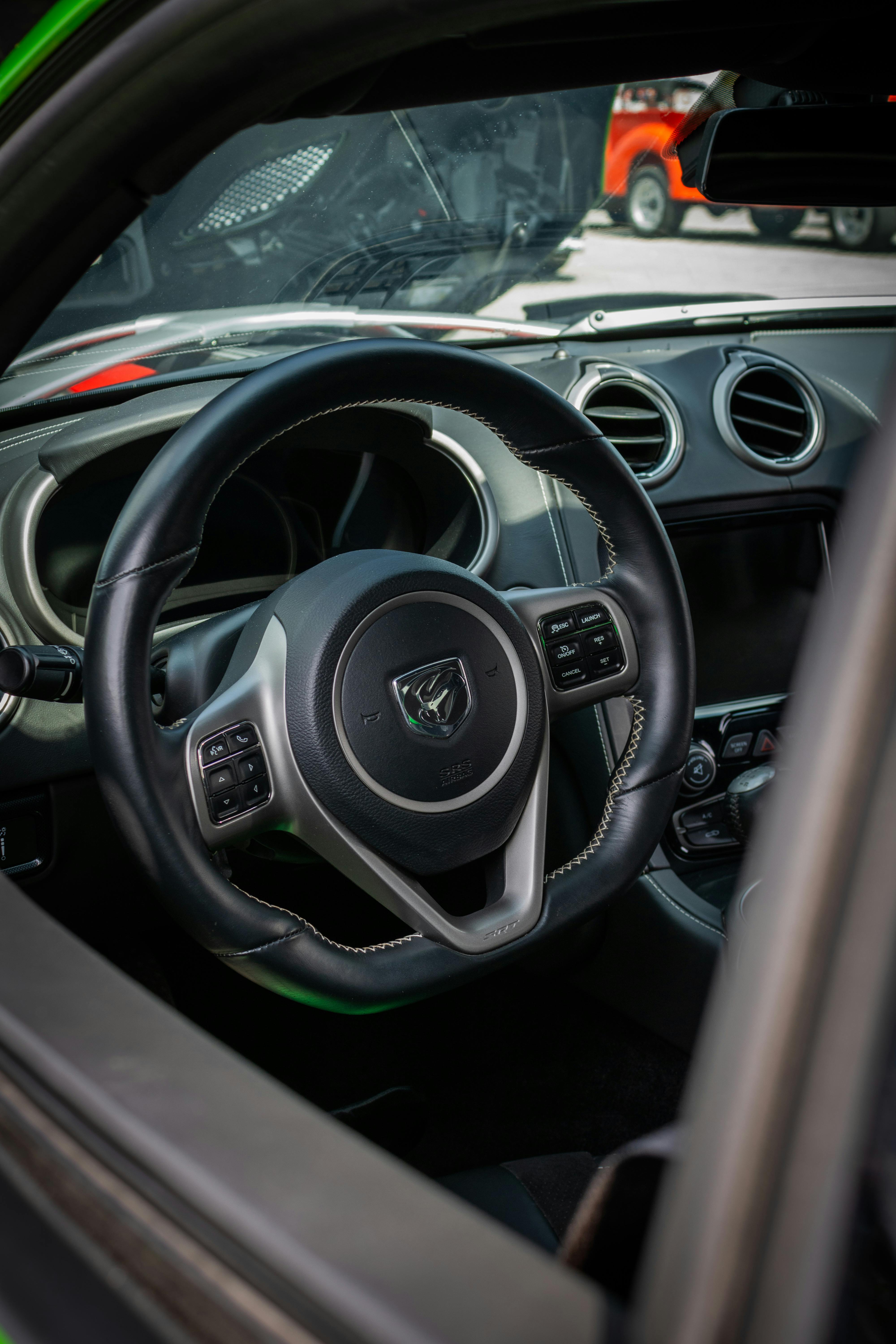 The interior of a green sports car · Free Stock Photo