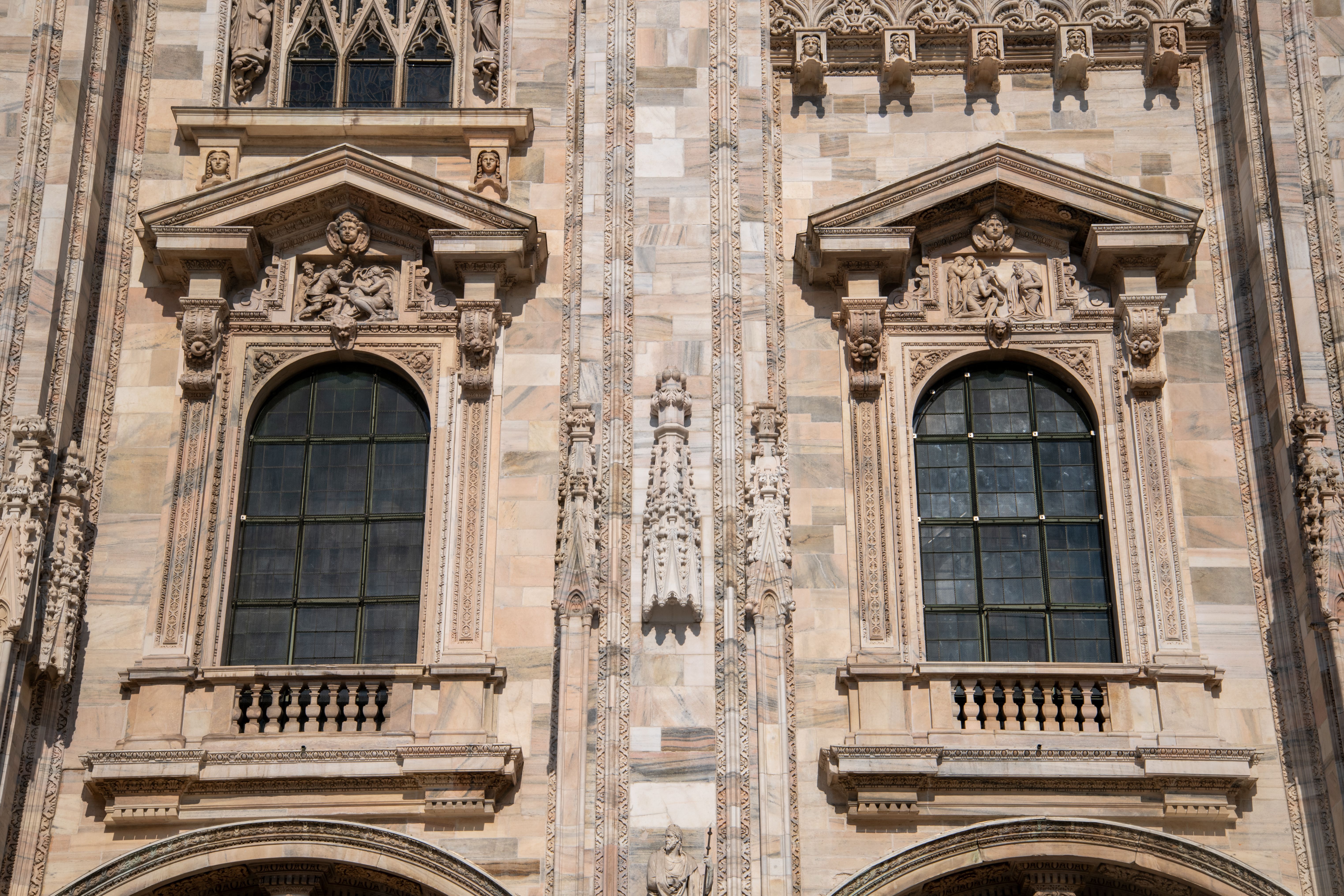 The facade of a building with ornate windows · Free Stock Photo