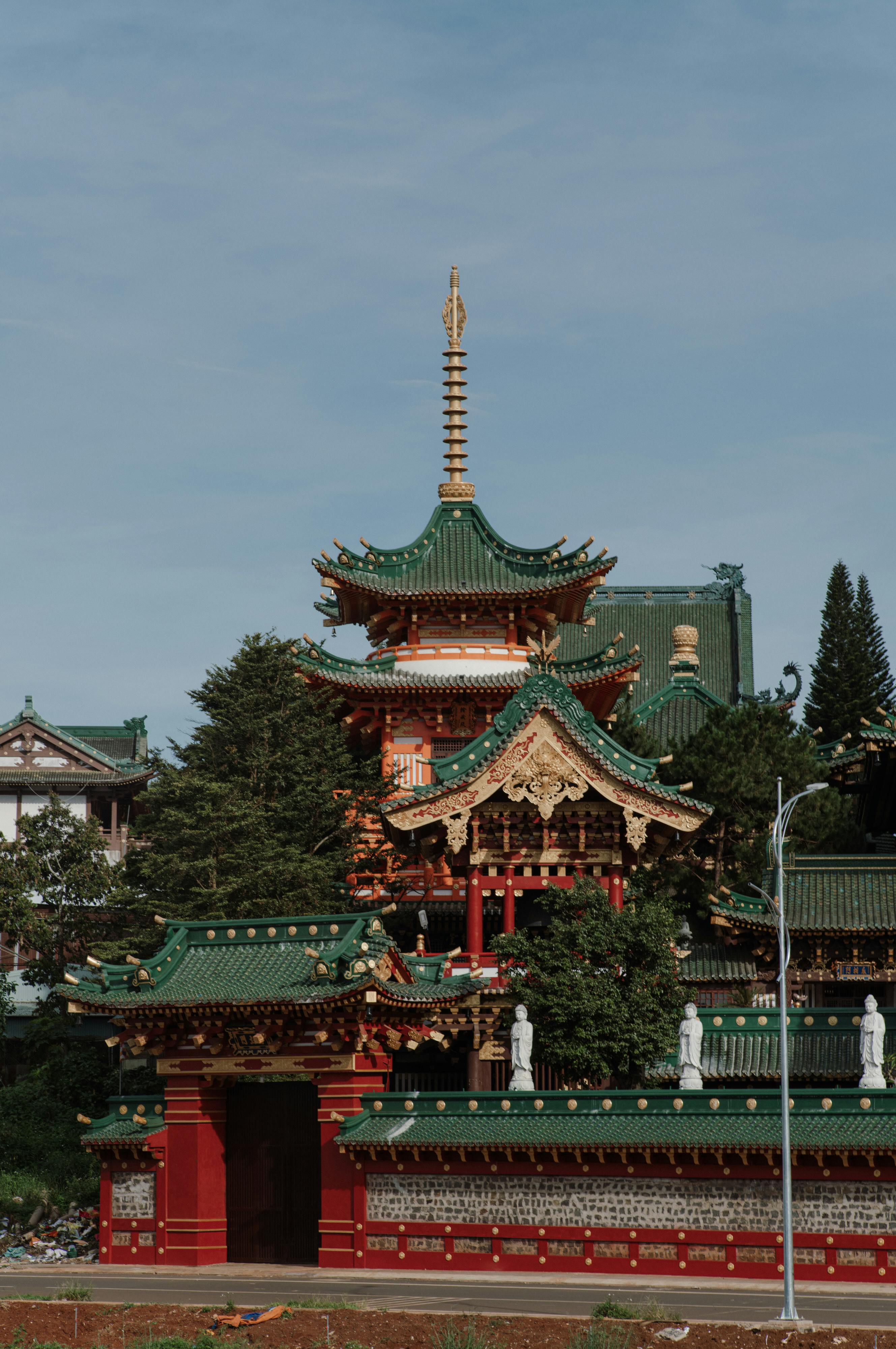 A large asian building with a green roof · Free Stock Photo