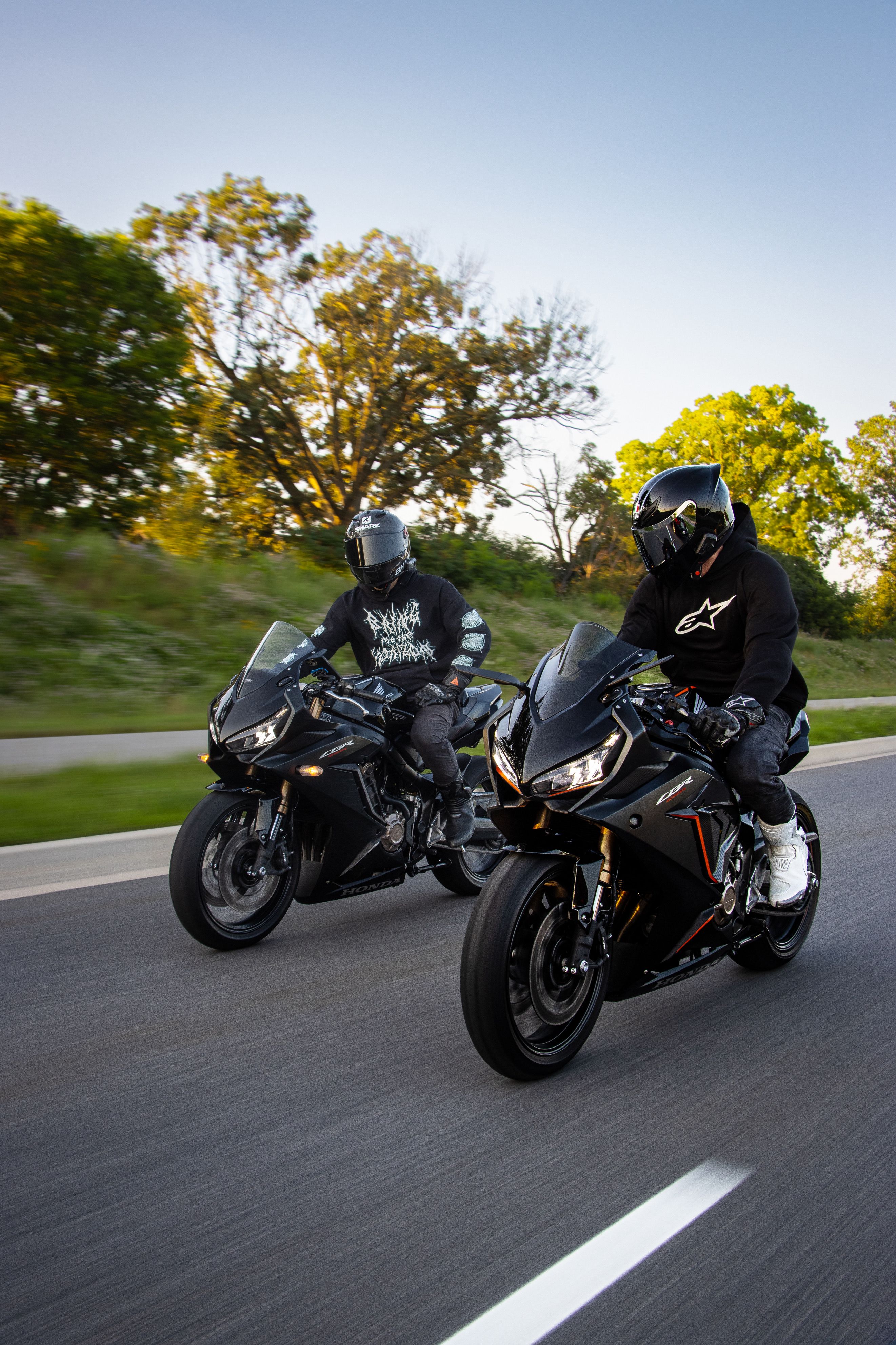 Two people riding motorcycles on a road · Free Stock Photo