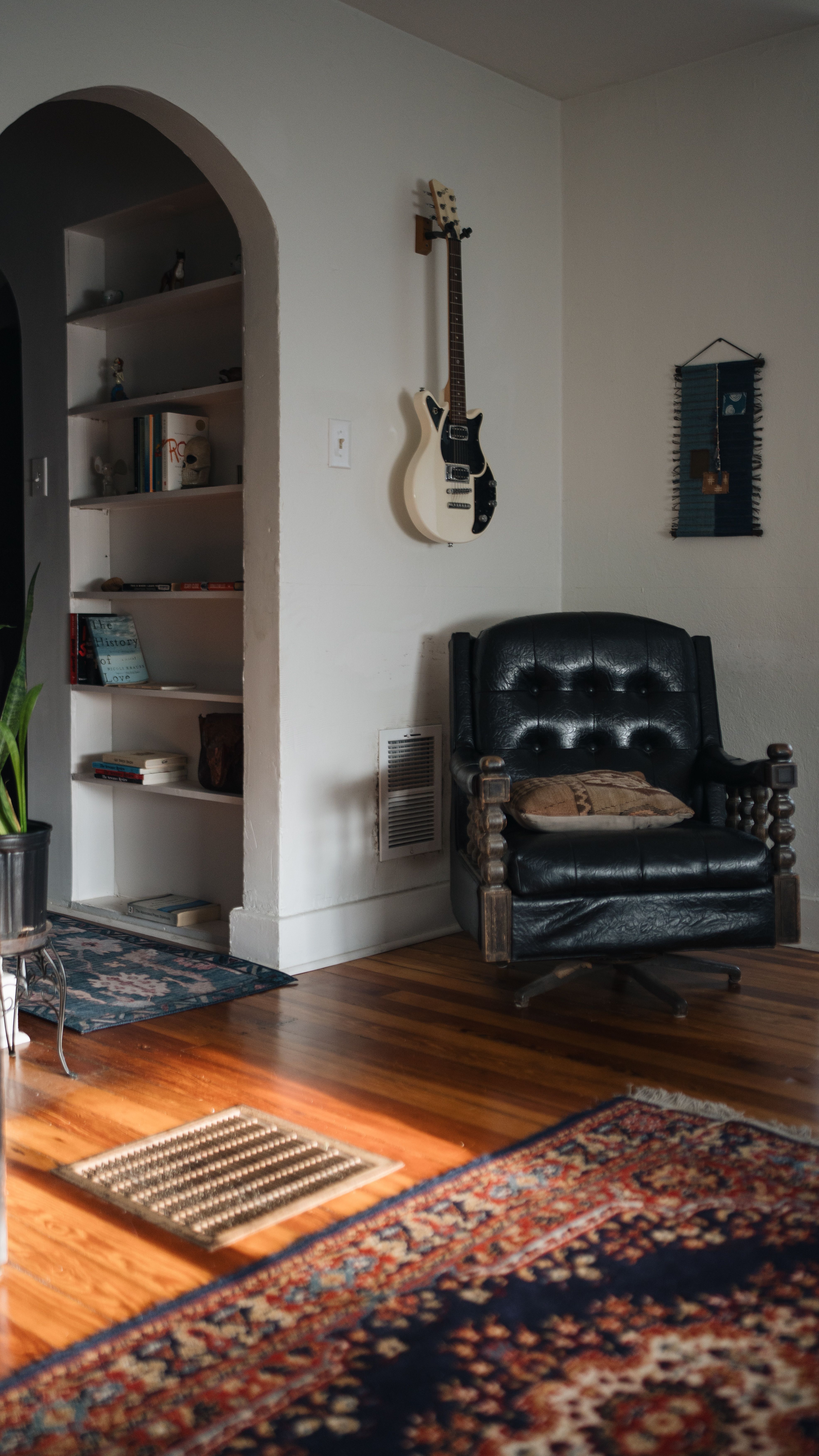 A living room with a guitar and a chair · Free Stock Photo